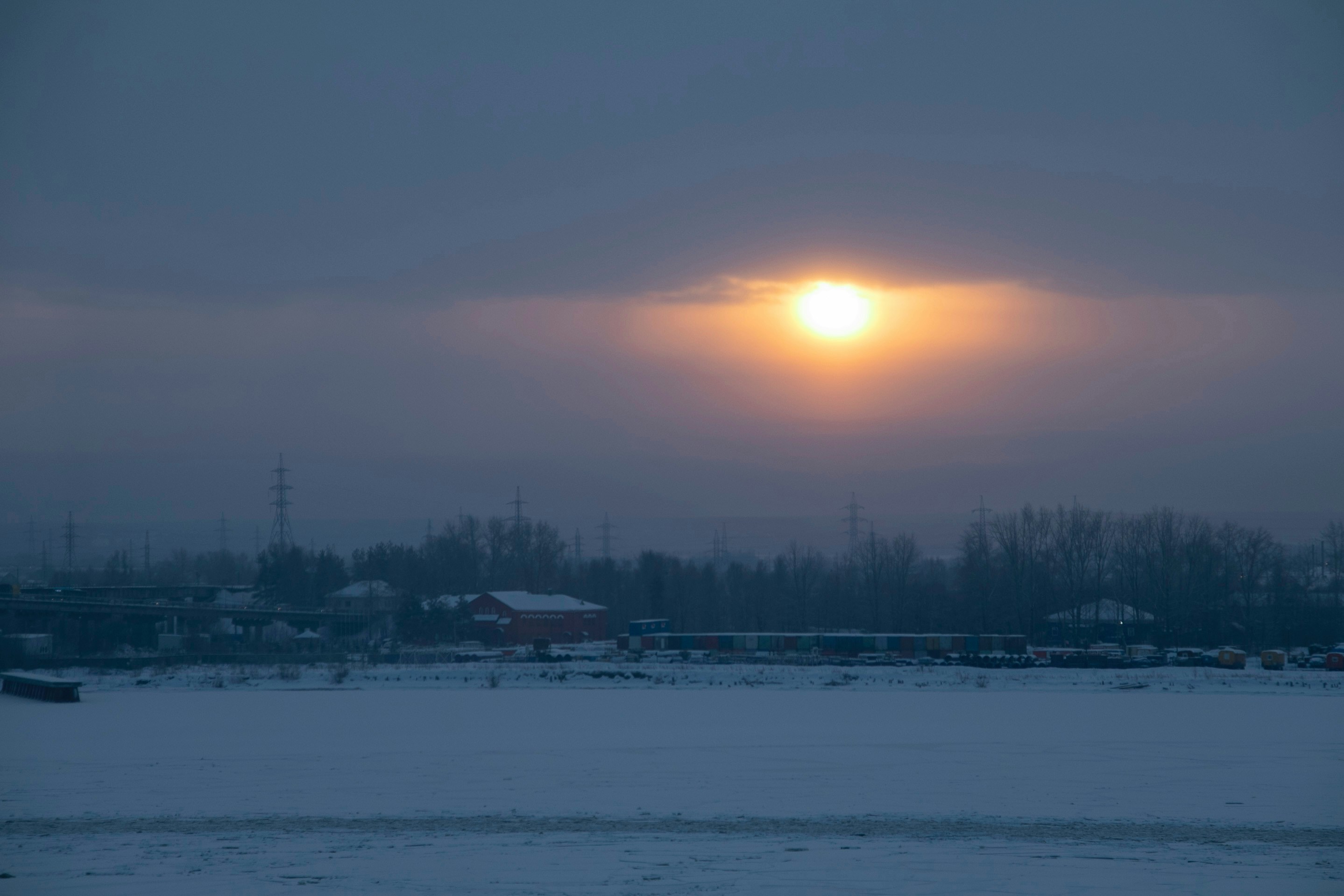 Low Horizon Glow: A Quiet Winter Sunset over a Frozen River