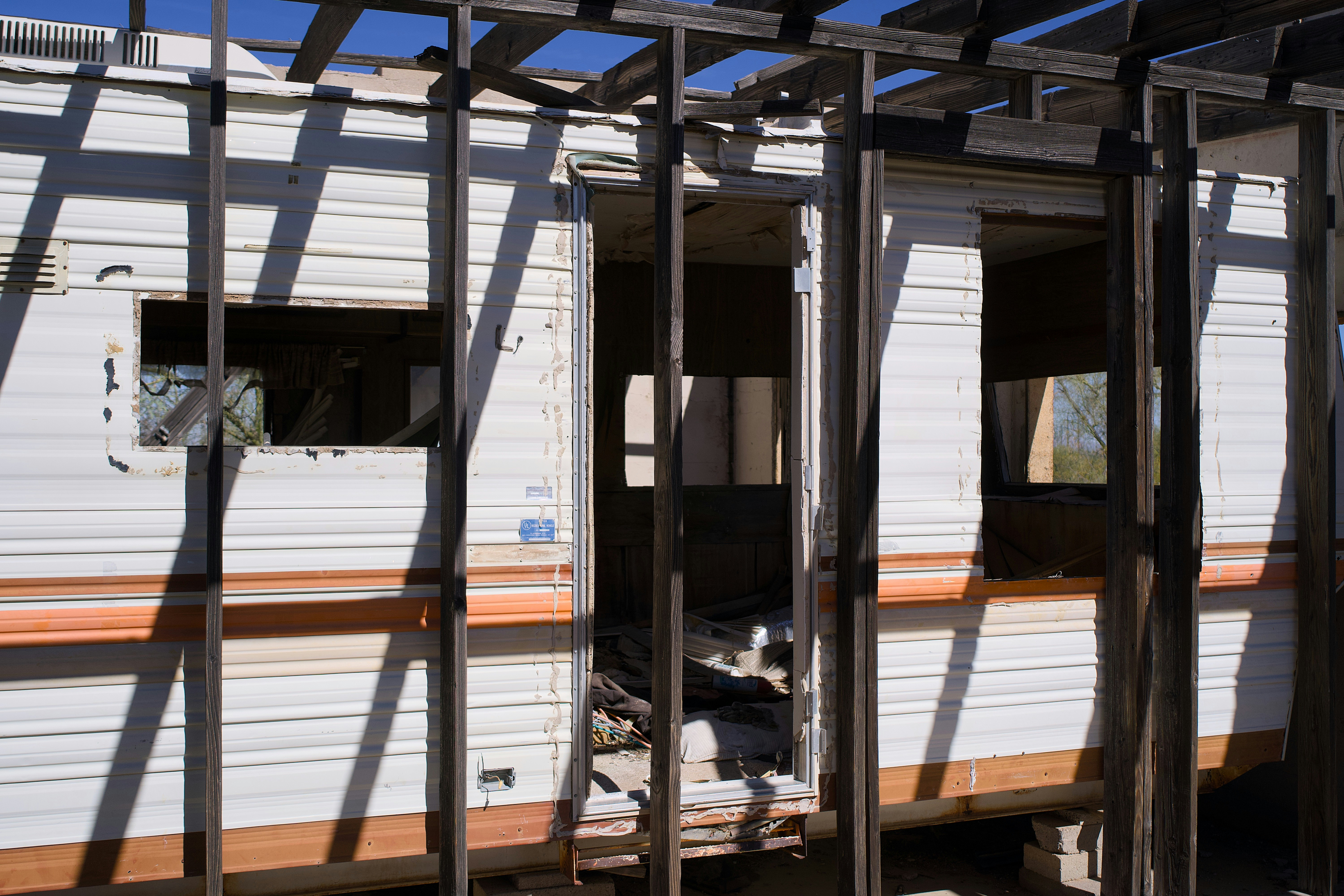 Abandoned train car skeleton under weathered beams