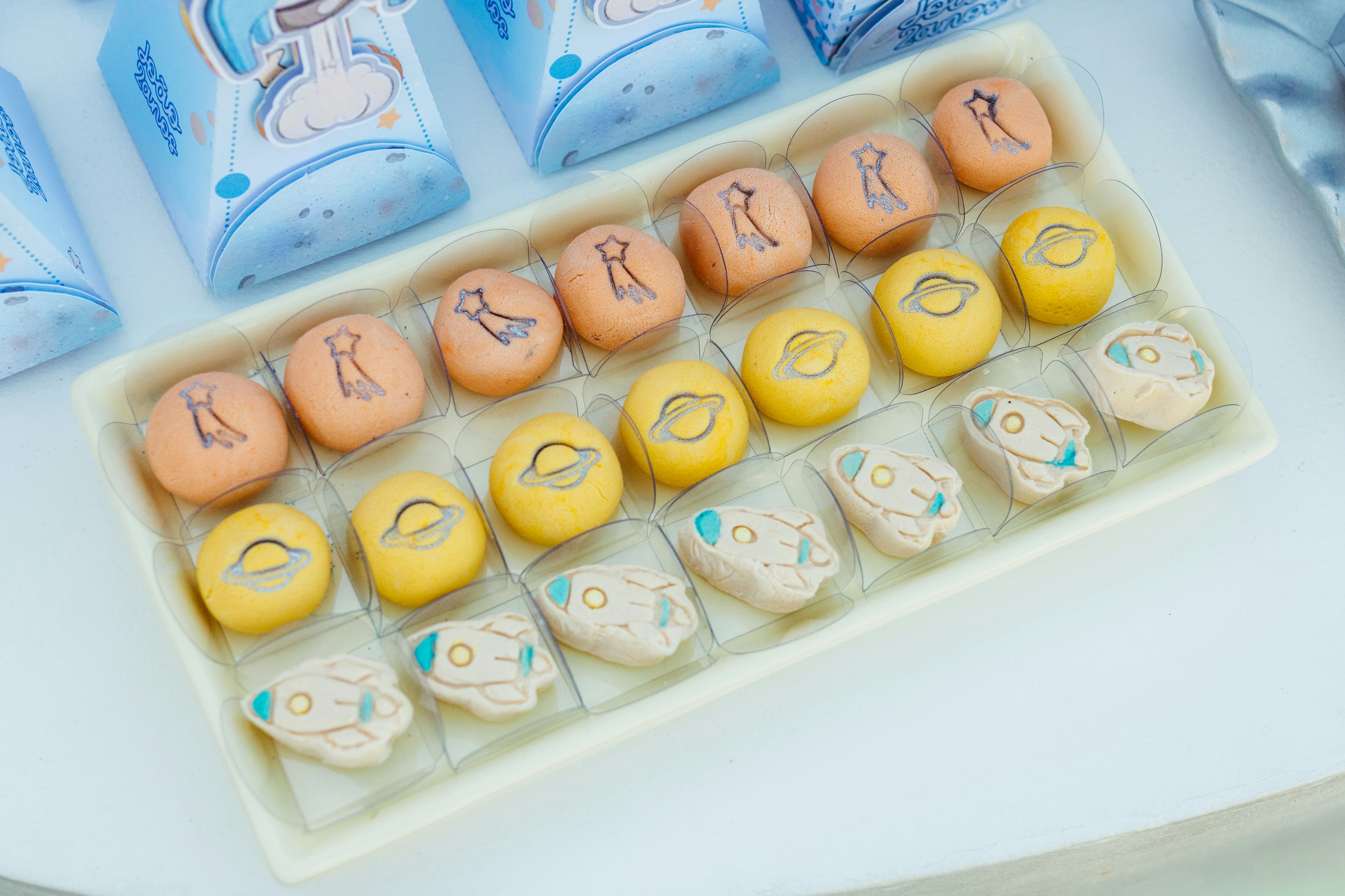 Colorful Row of Decorated Pastry Balls in a Tray