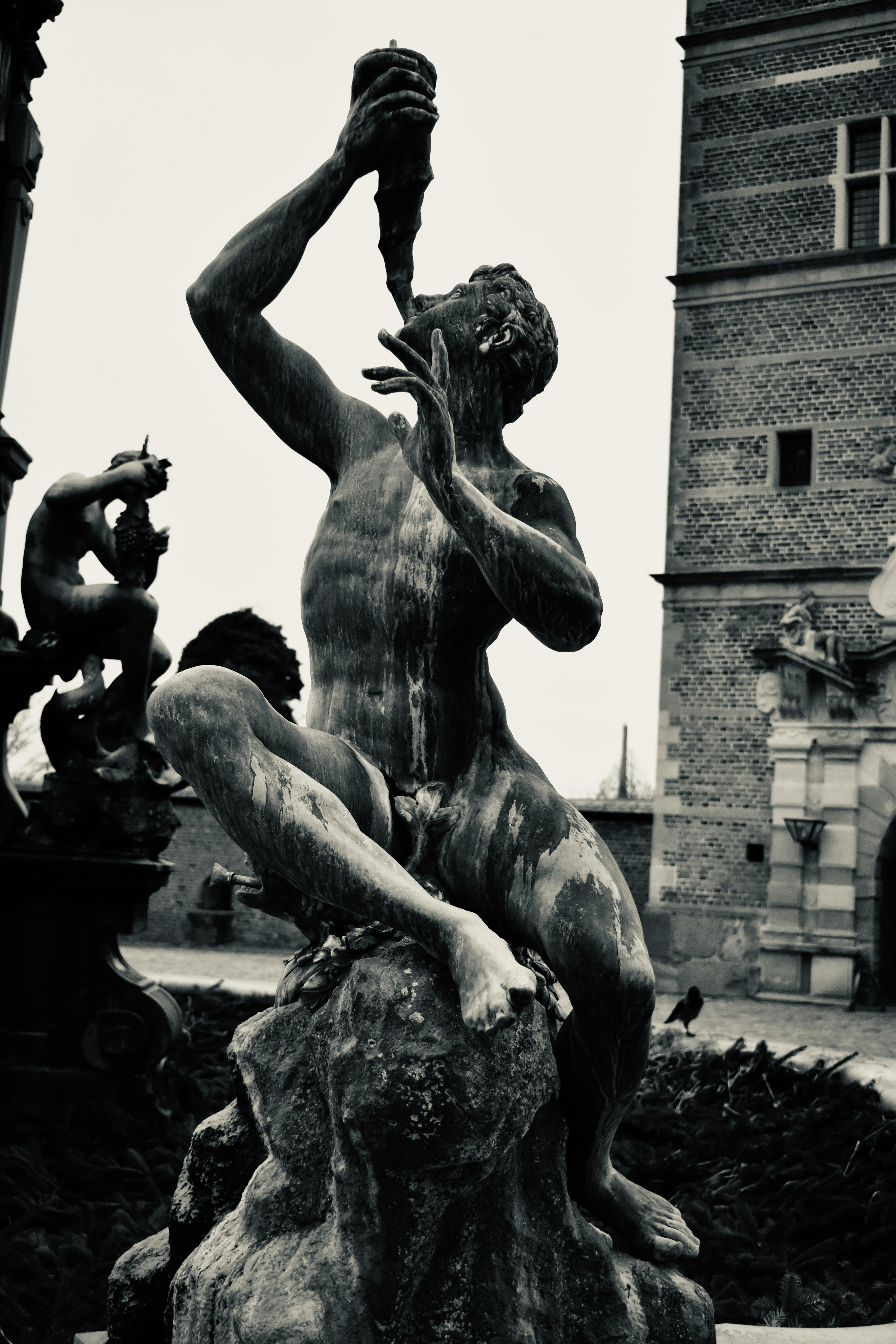 Echo of the Guttural Muse: A statue’s drenched motion under brick and sky
