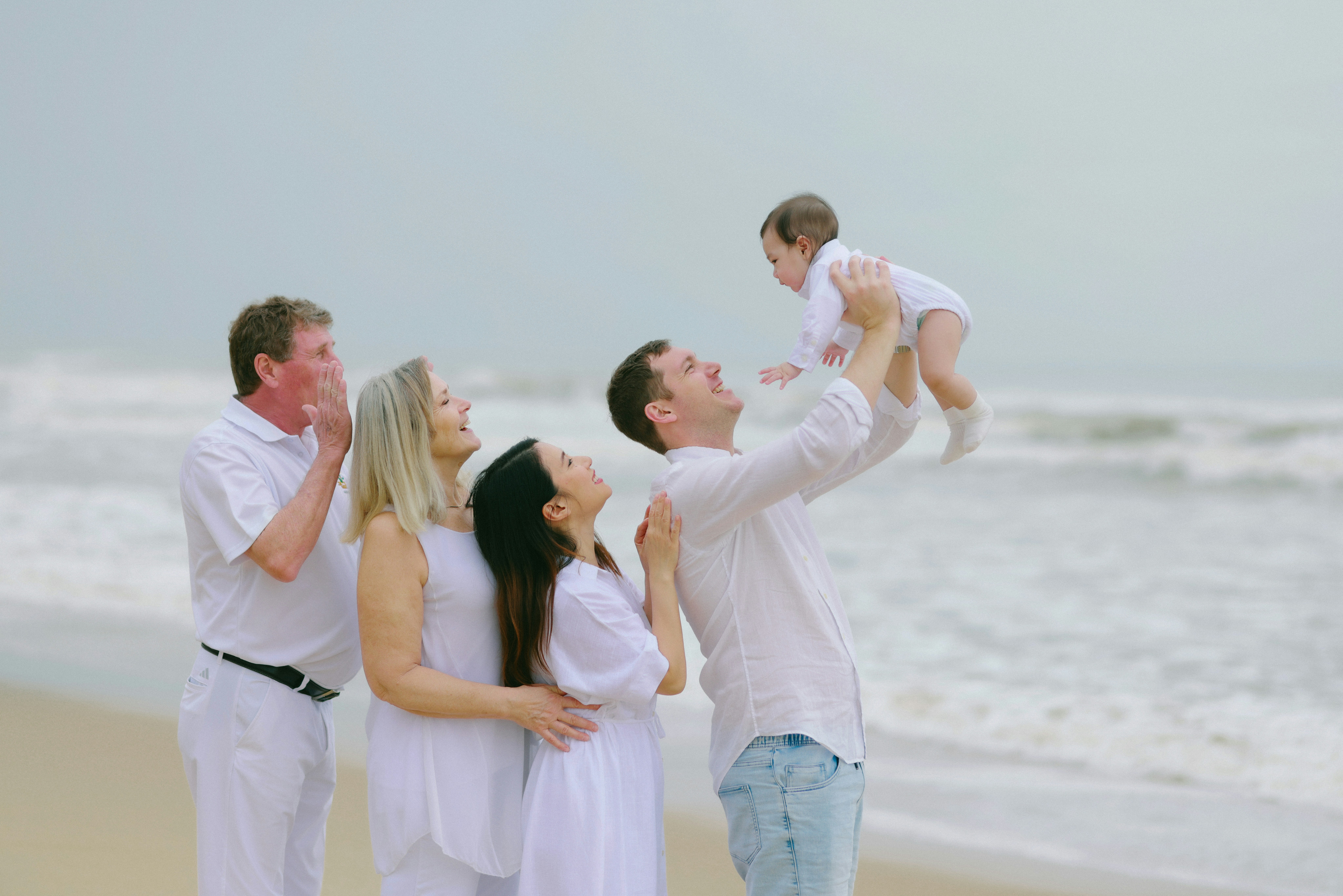 Family on beach with father holding baby in air photo – Free Beach ...