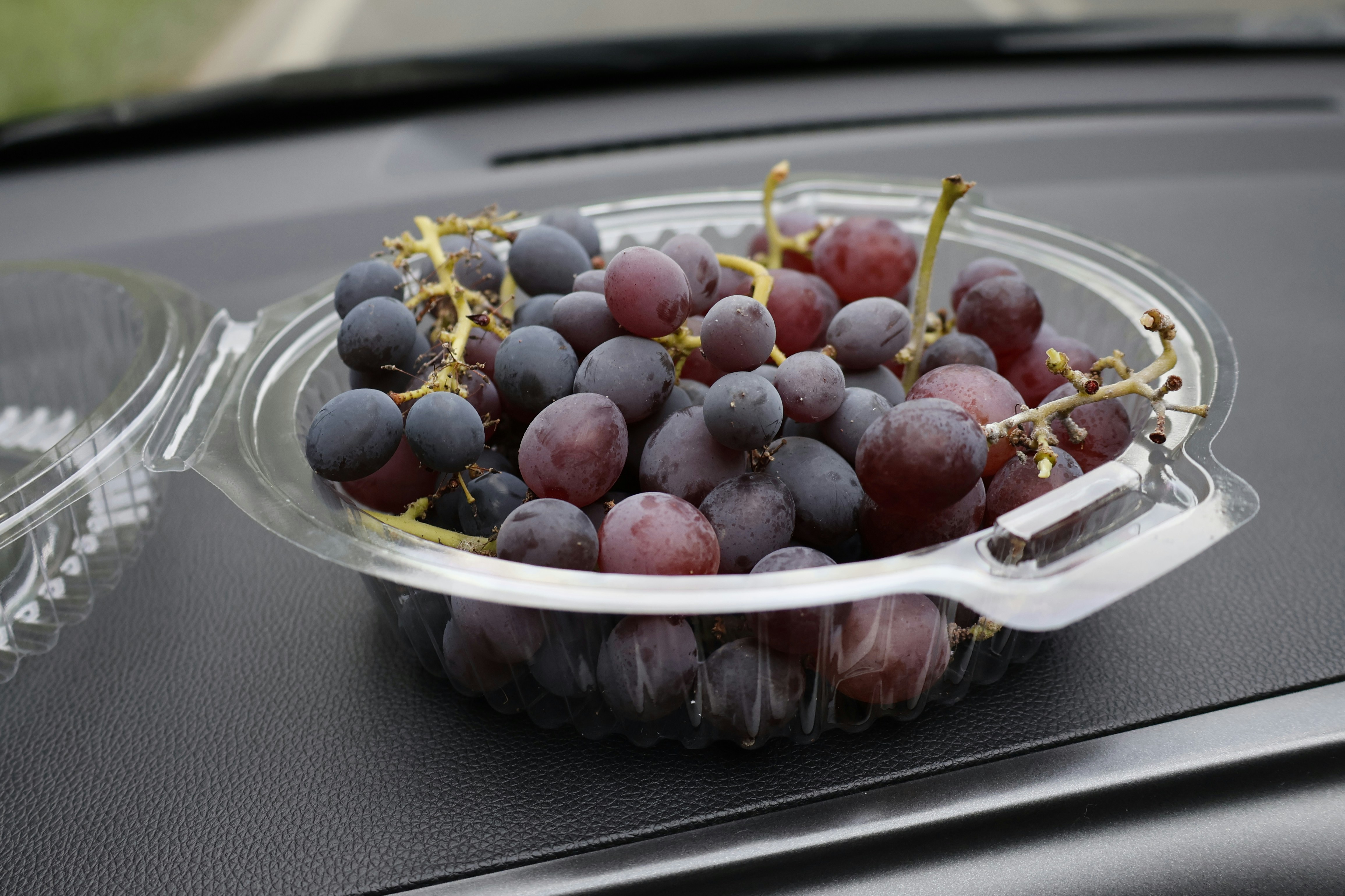 Grapes in a Clear Capsule: On a Car Dashboard