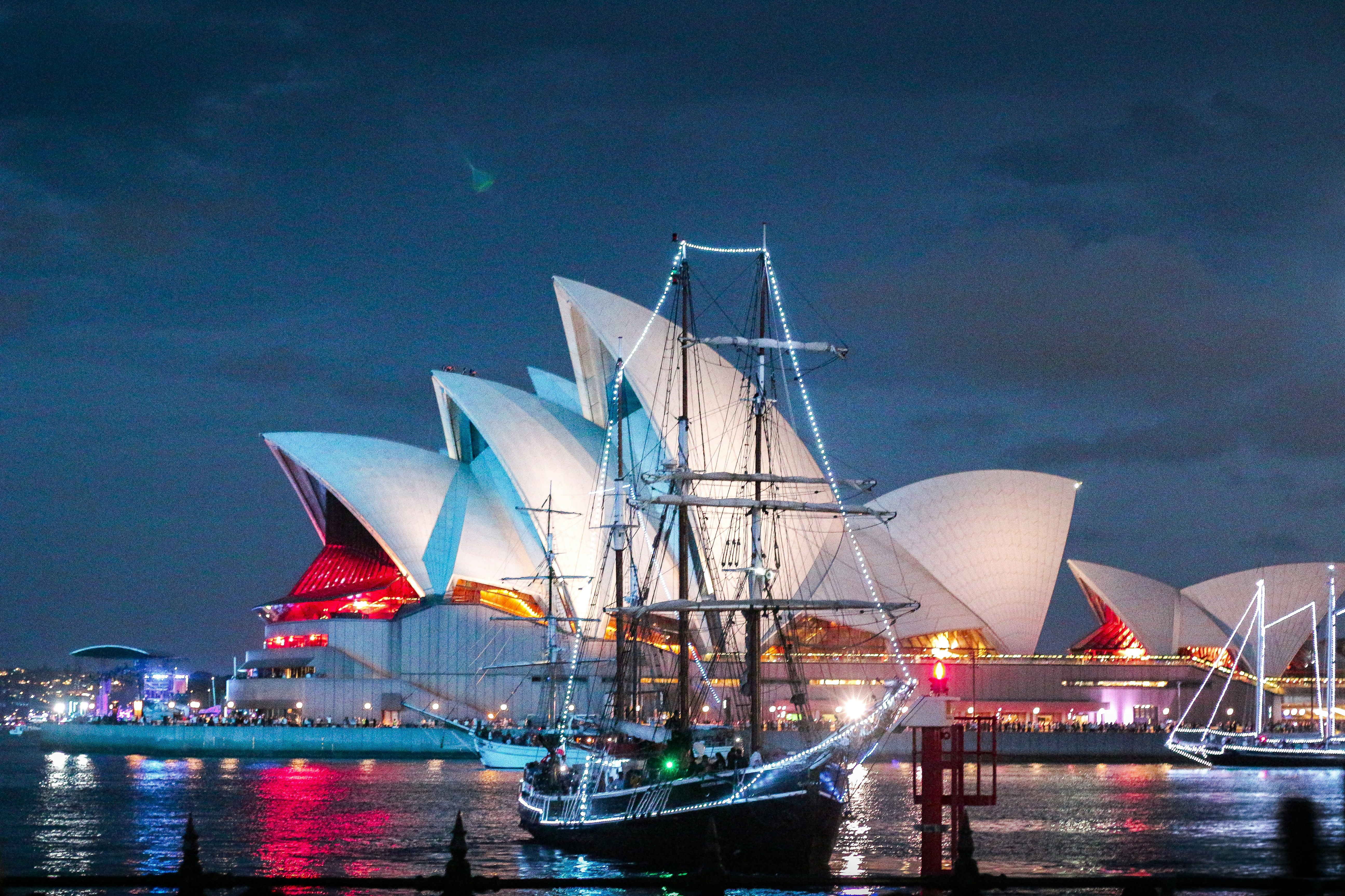 Moonlit Sail: A Classic Schooner against Sydney's Opera House Nightscape