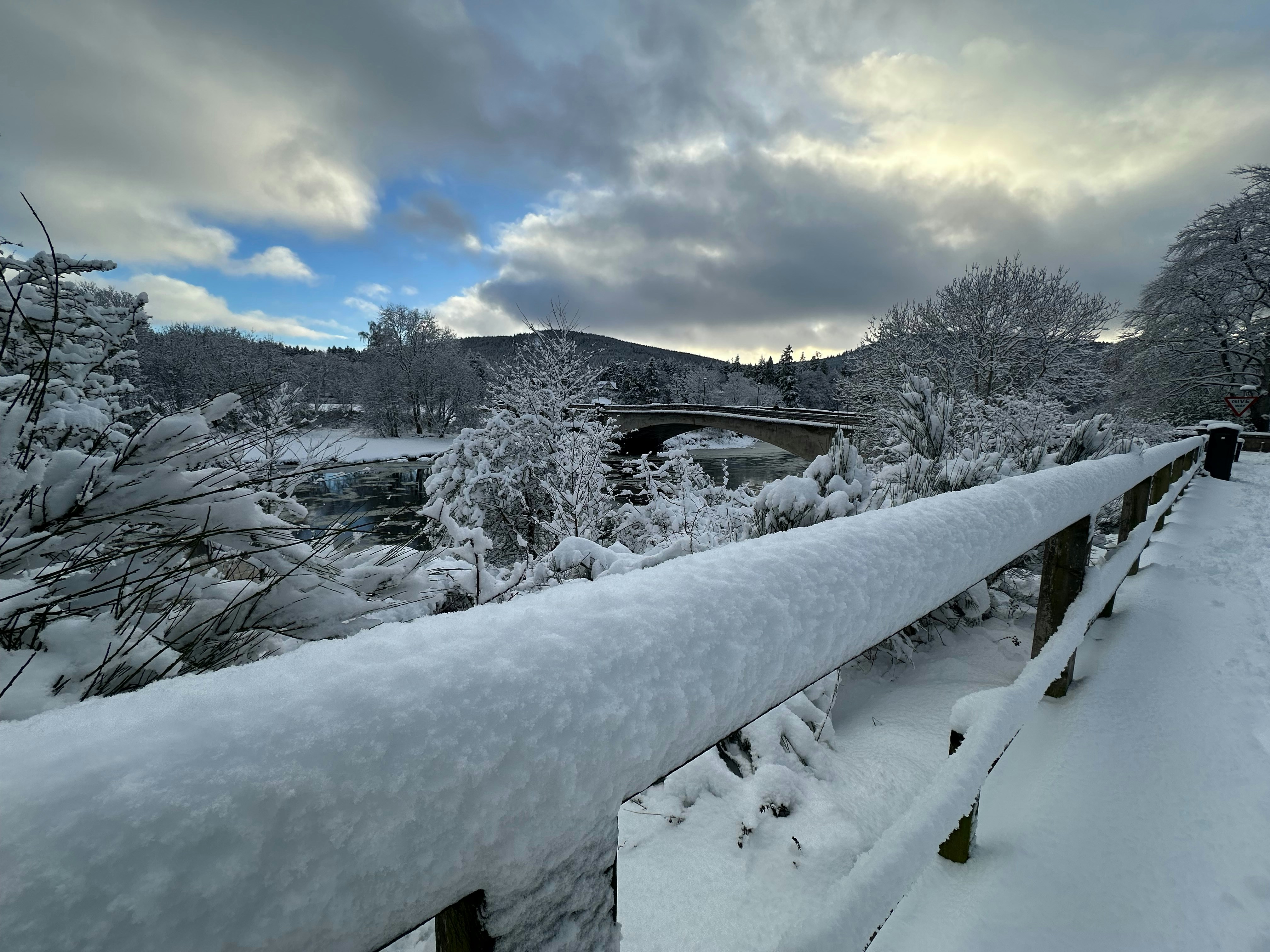 Snowbound Riverside: A Quiet Bridge Across a Frosted Landscape