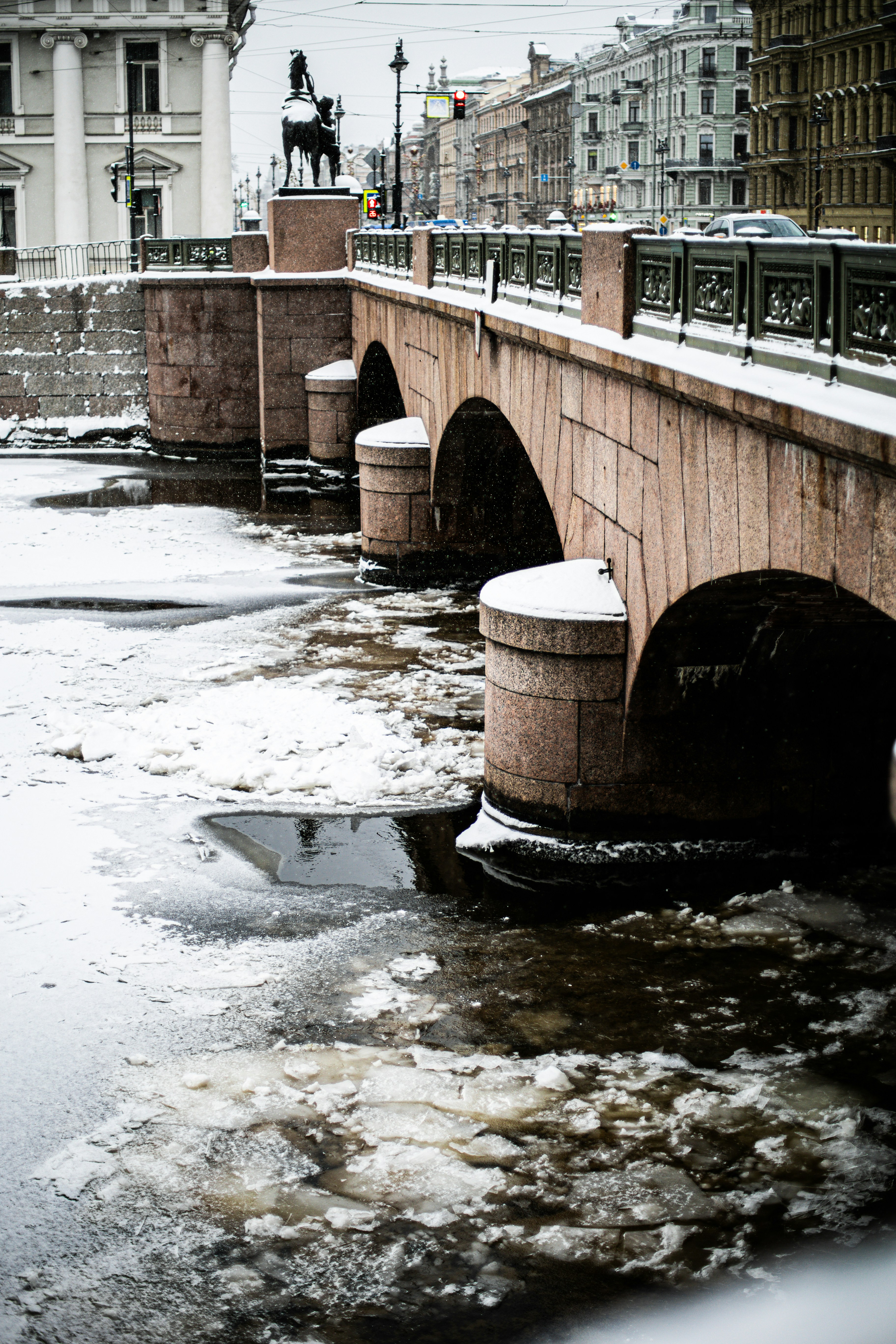 Winter on the Stone Bridge: Snowlit Arches and Reflections