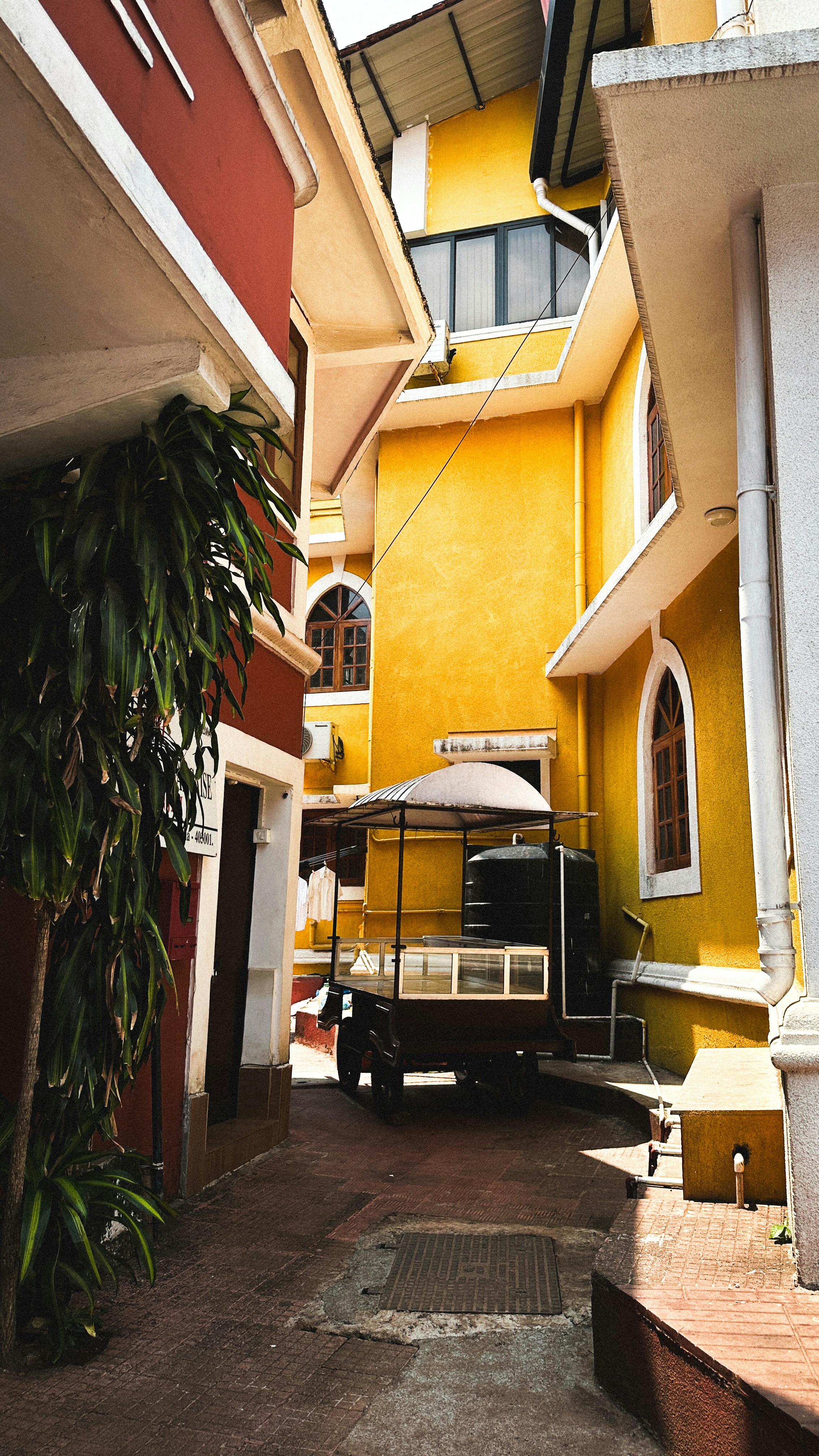 Yellow Courtyard Carousel: A Narrow Lane Between Bright Facades