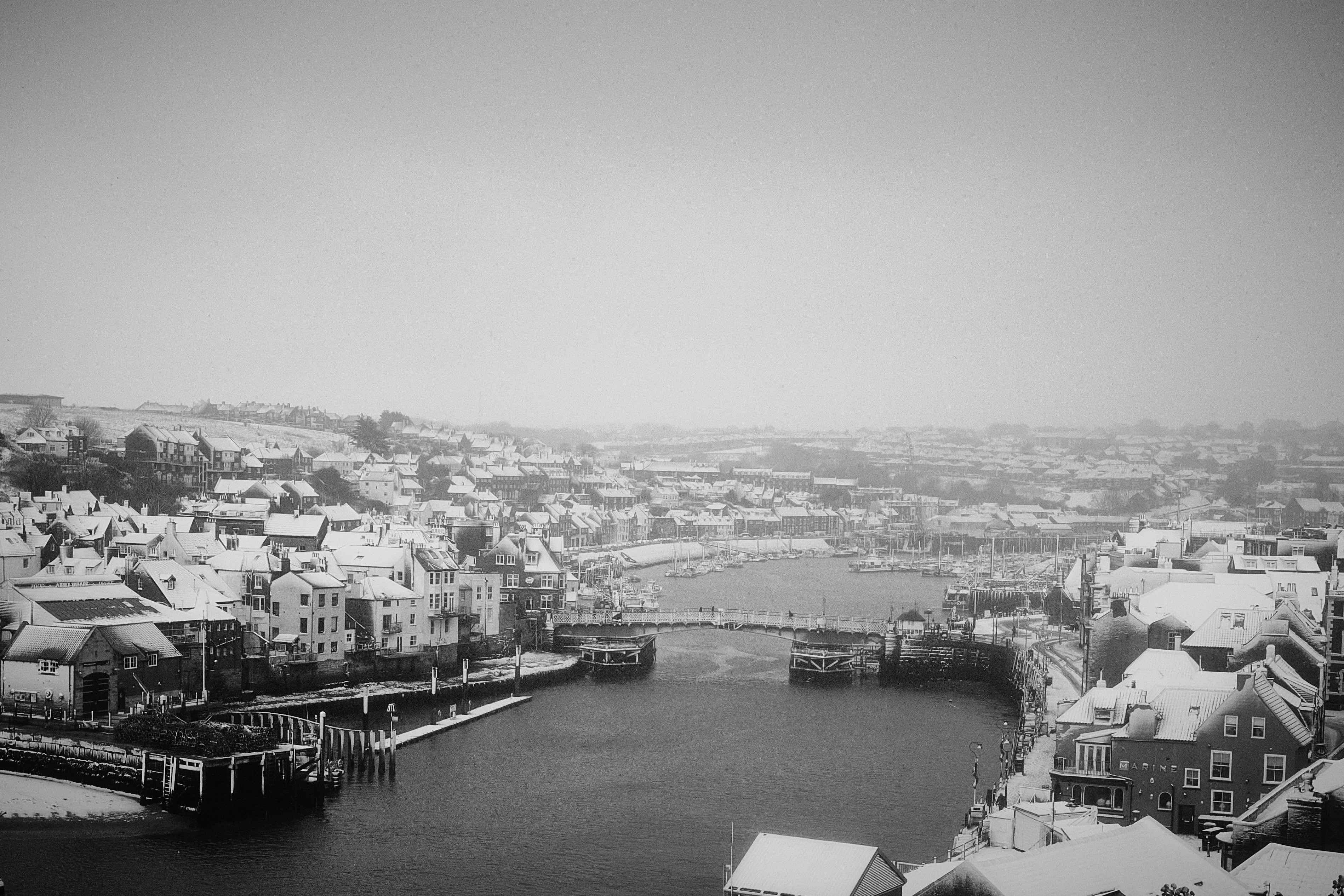 Harbor Town in monochrome: snow-dusted docks and quiet water