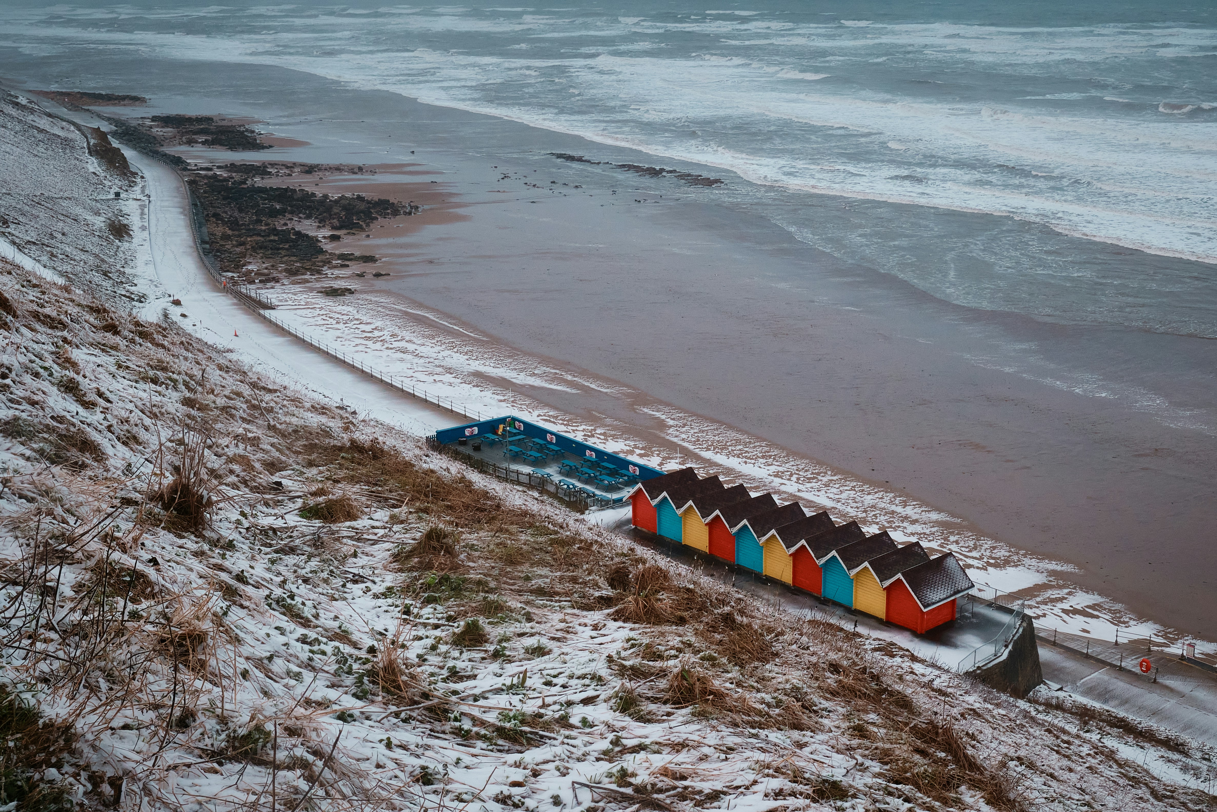 Row of Colorful Beach Cabins Guarding the Quiet Shore