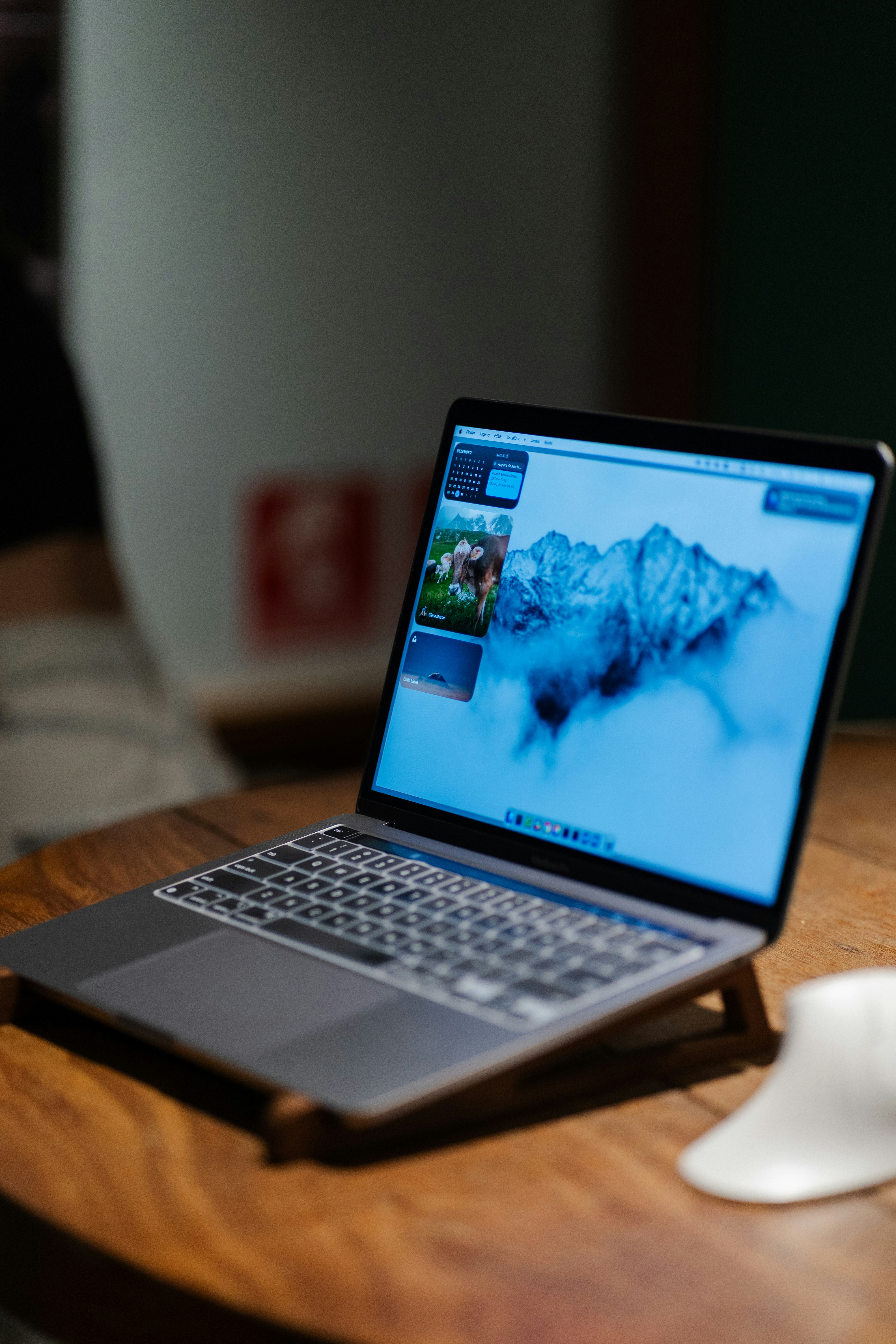 Low-angle Focus: A laptop calmly illuminated on a wooden table