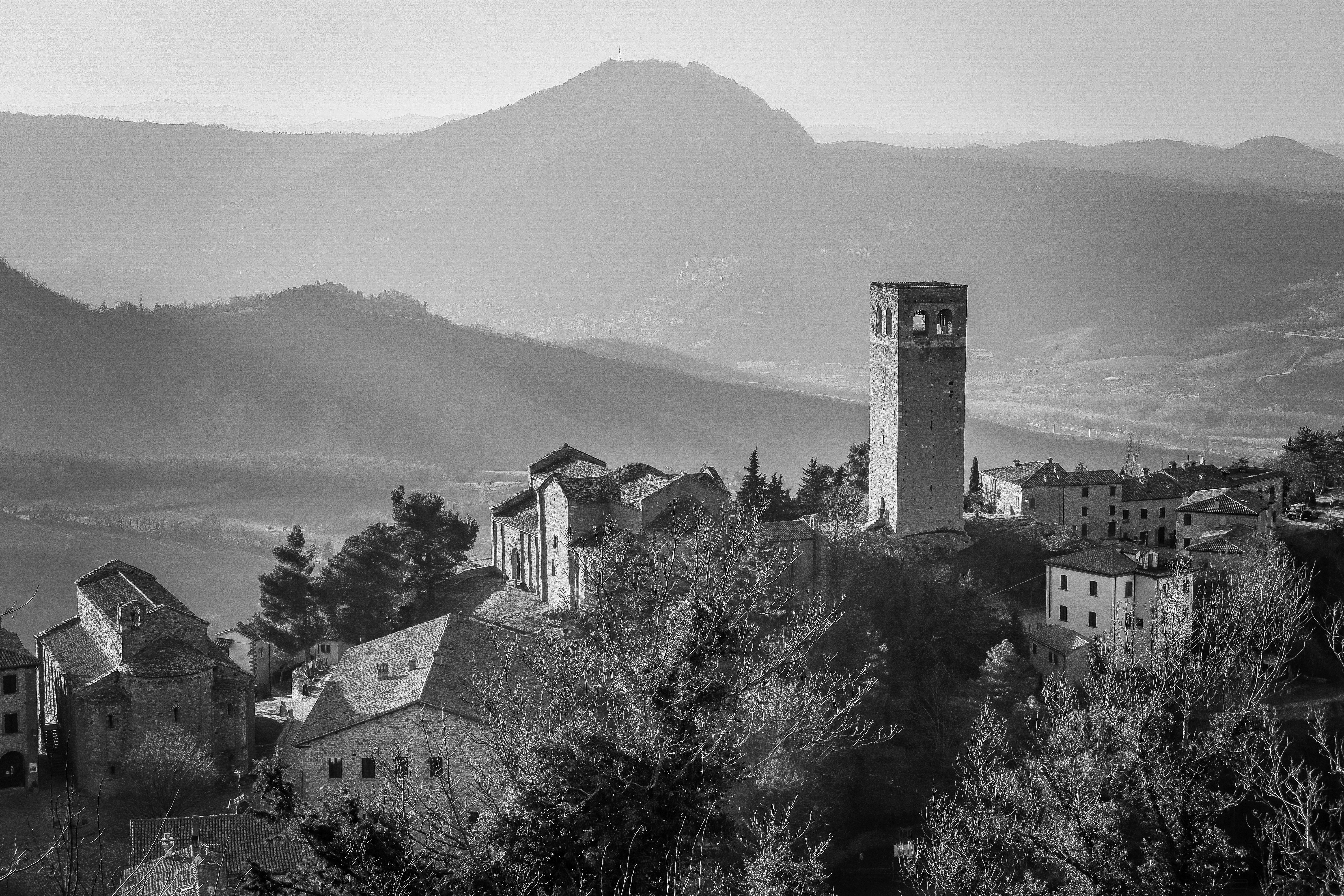 Ancient Village Silhouette Under Distant Peak