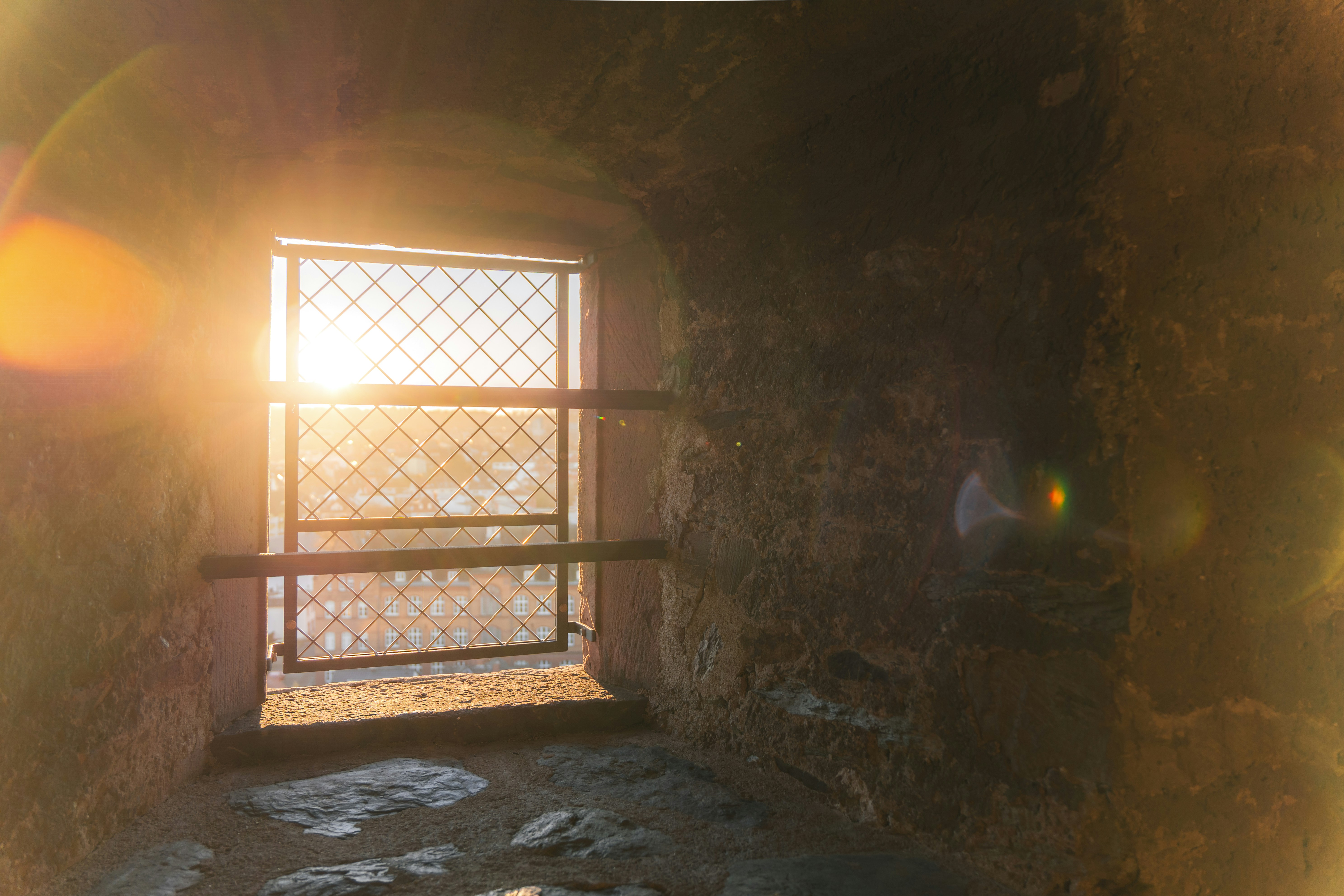 Sunrise Gate: Light through the Gridded Window of a Dim Cave