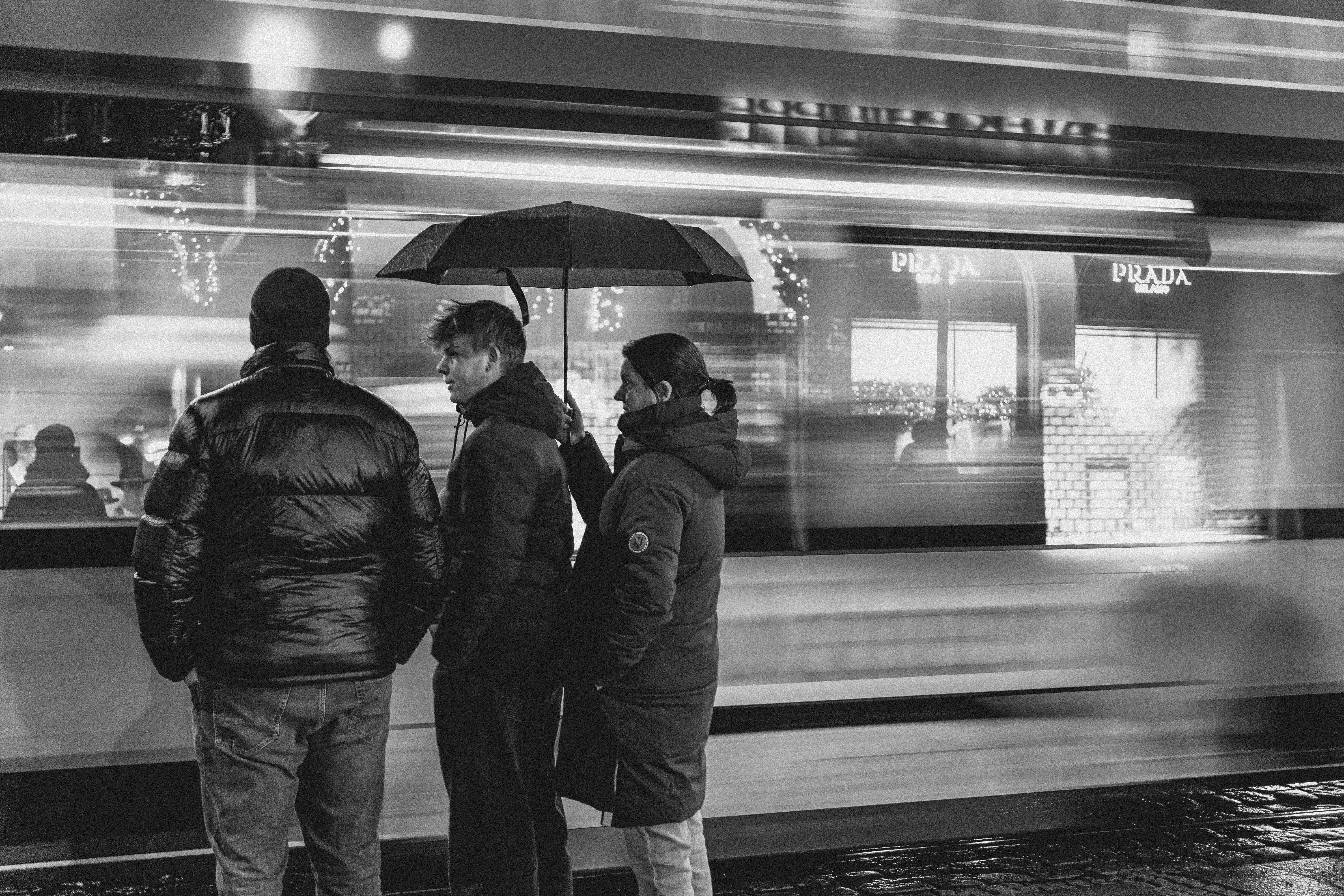 Umbrella Pause: A Quiet Moment at the Metro Edge