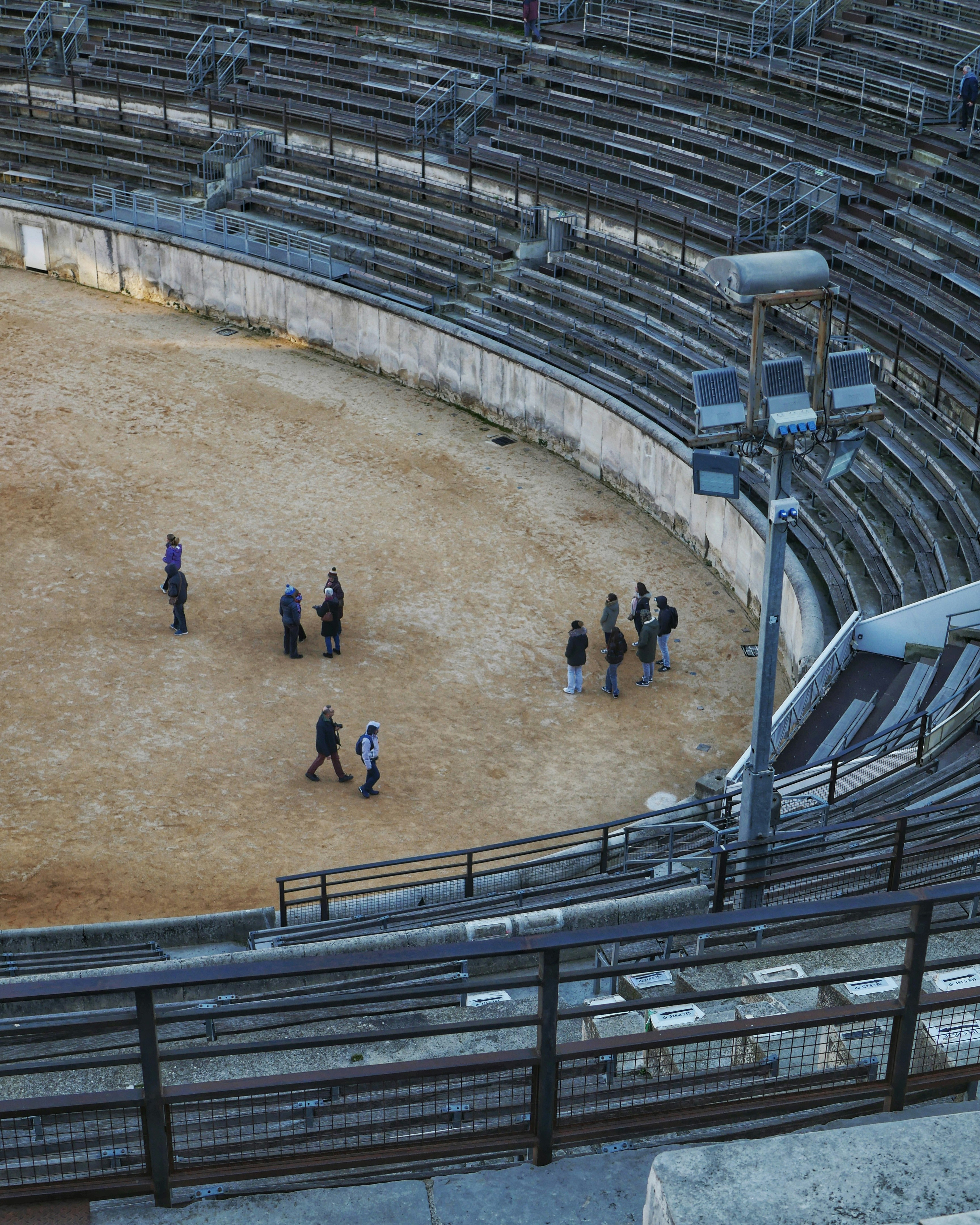 Vantage Across the Arena: A Sparse Crowd in an Aged Amphitheater
