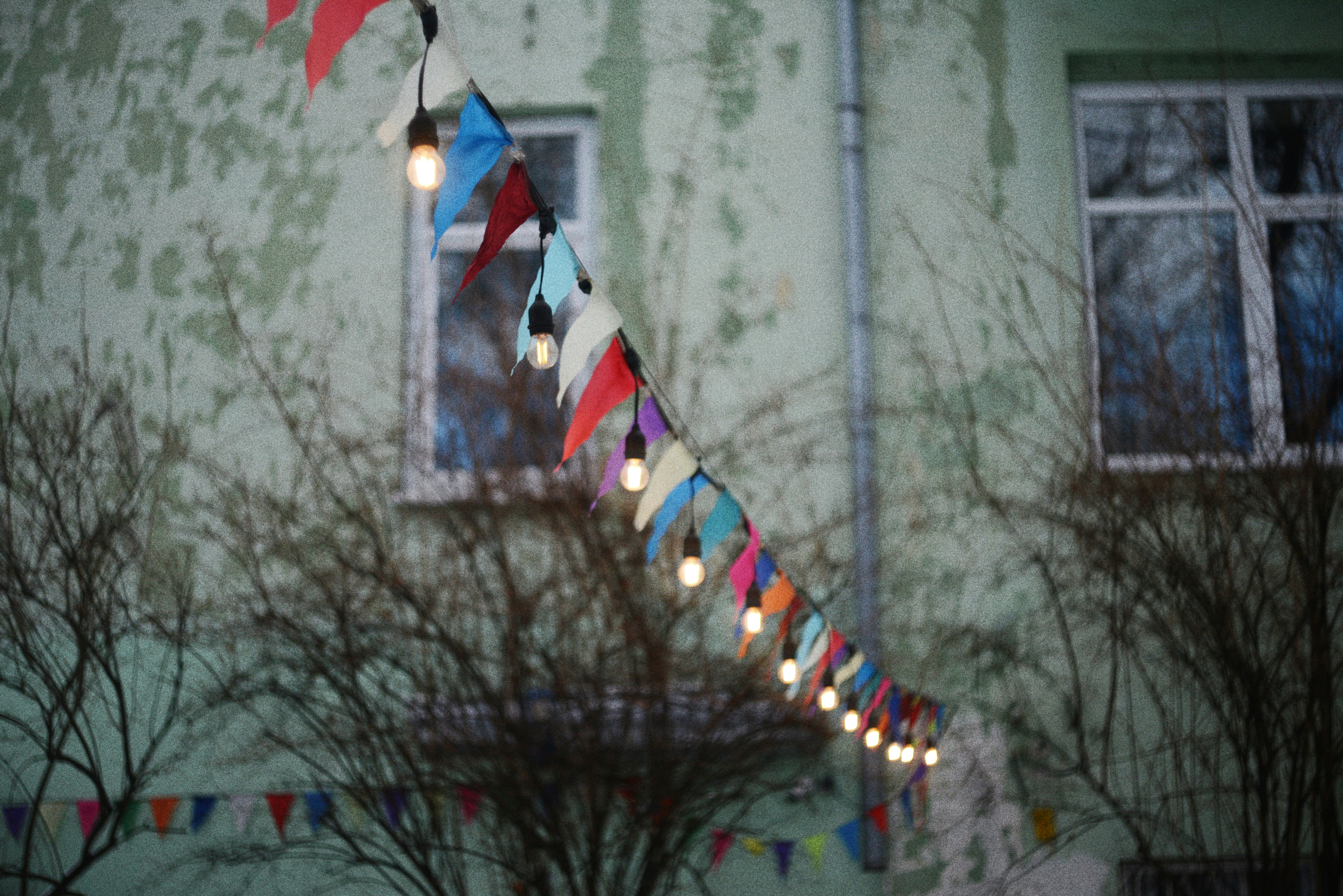 String of Colorful Lights Across a Quiet Facade
