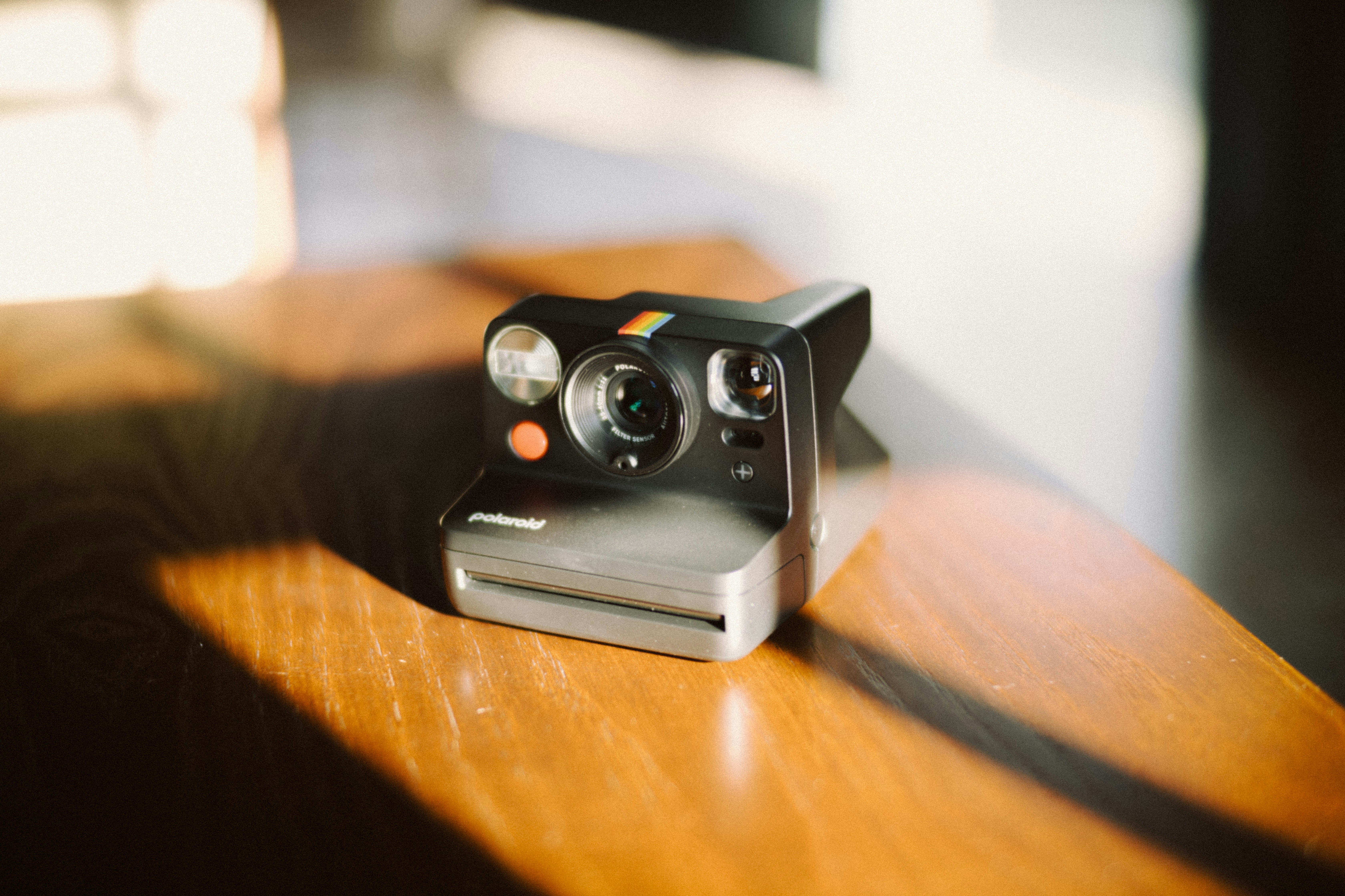 Time Capsule on a Table: A Retro Instant Camera in Soft Sunlight