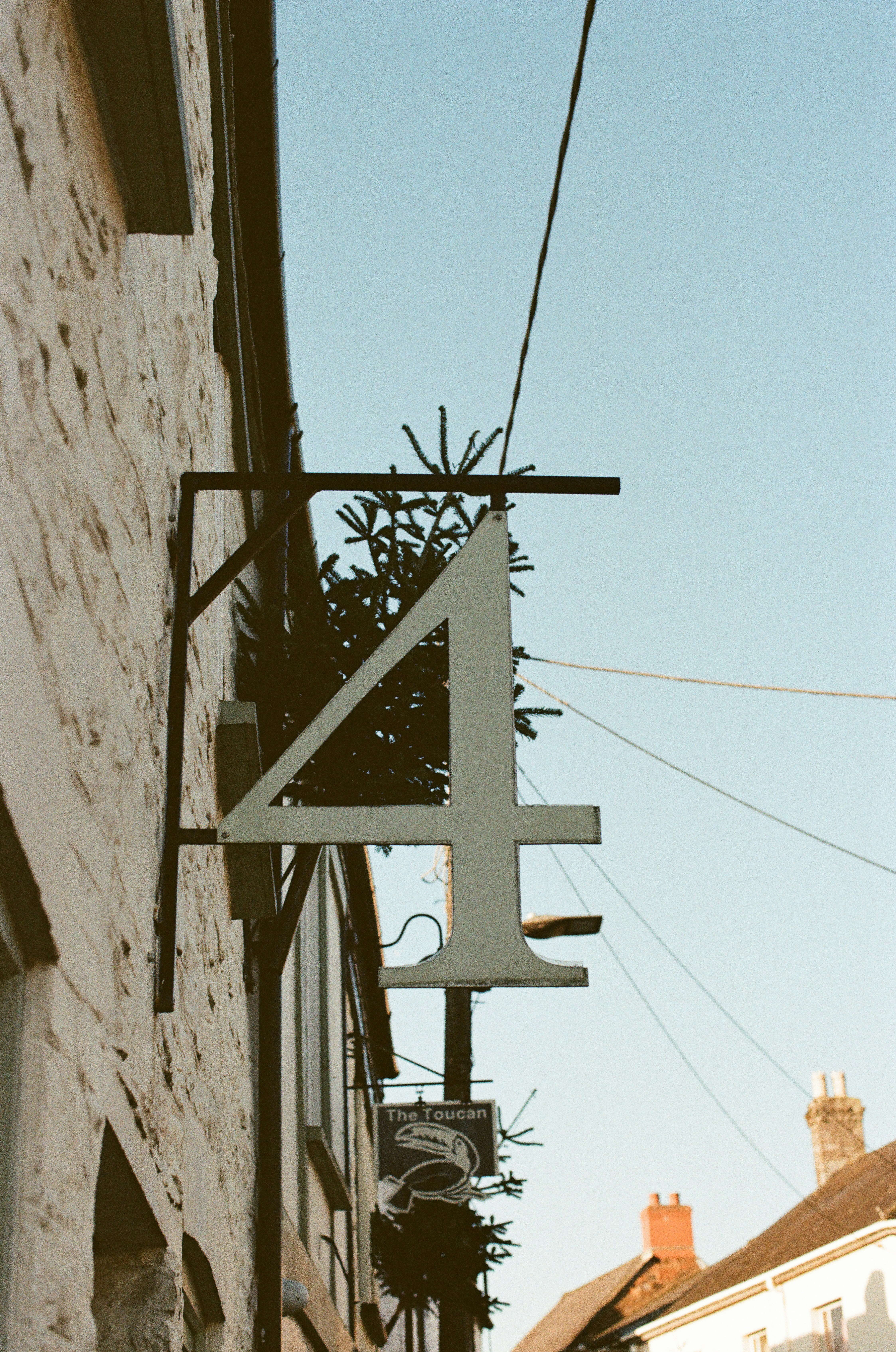 A large number four sign hangs on a building. photo – Free Clear sky ...