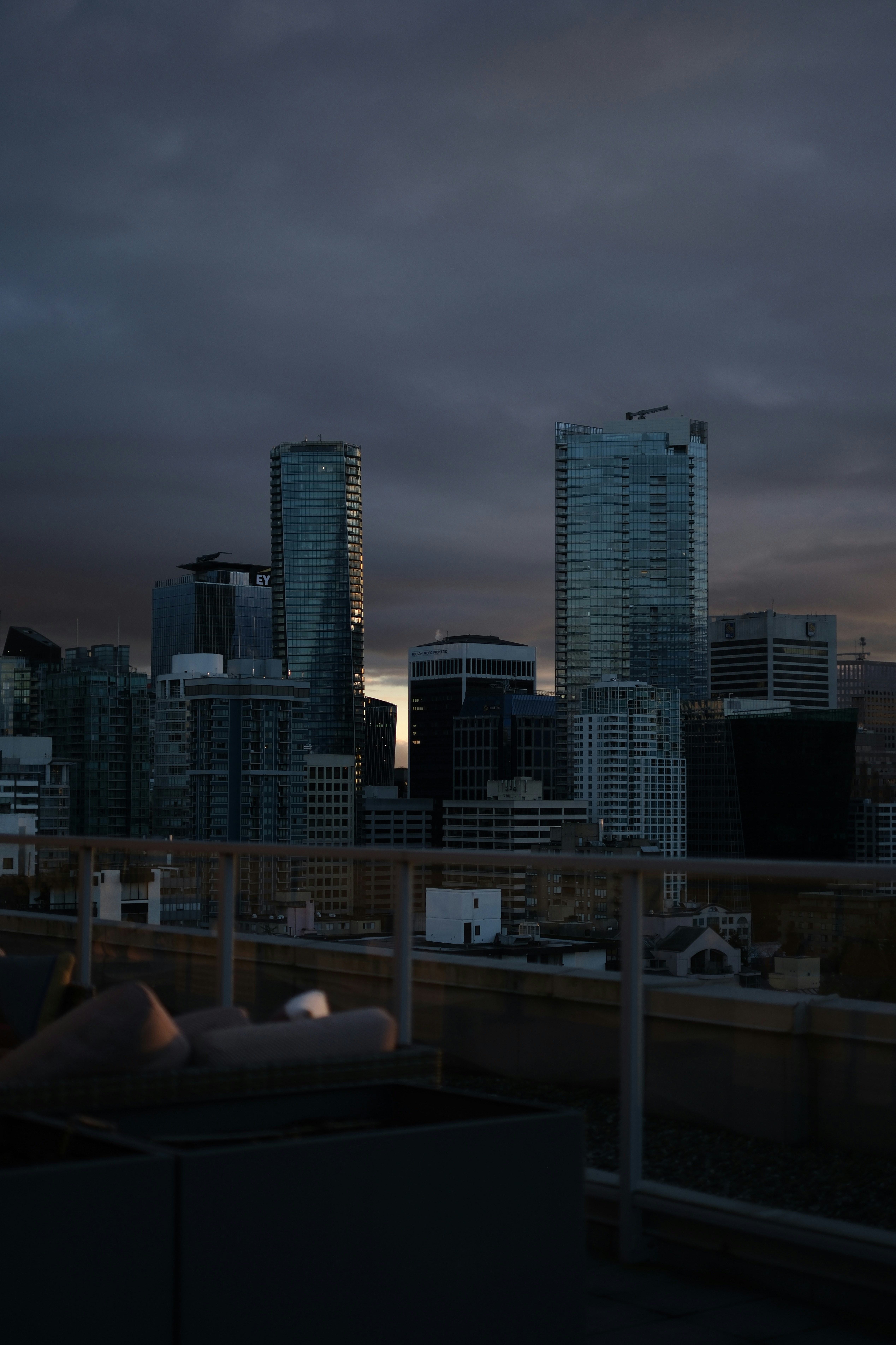 City Skyline at Dusk: Boats, Glass, and Quiet Rooftop Lights