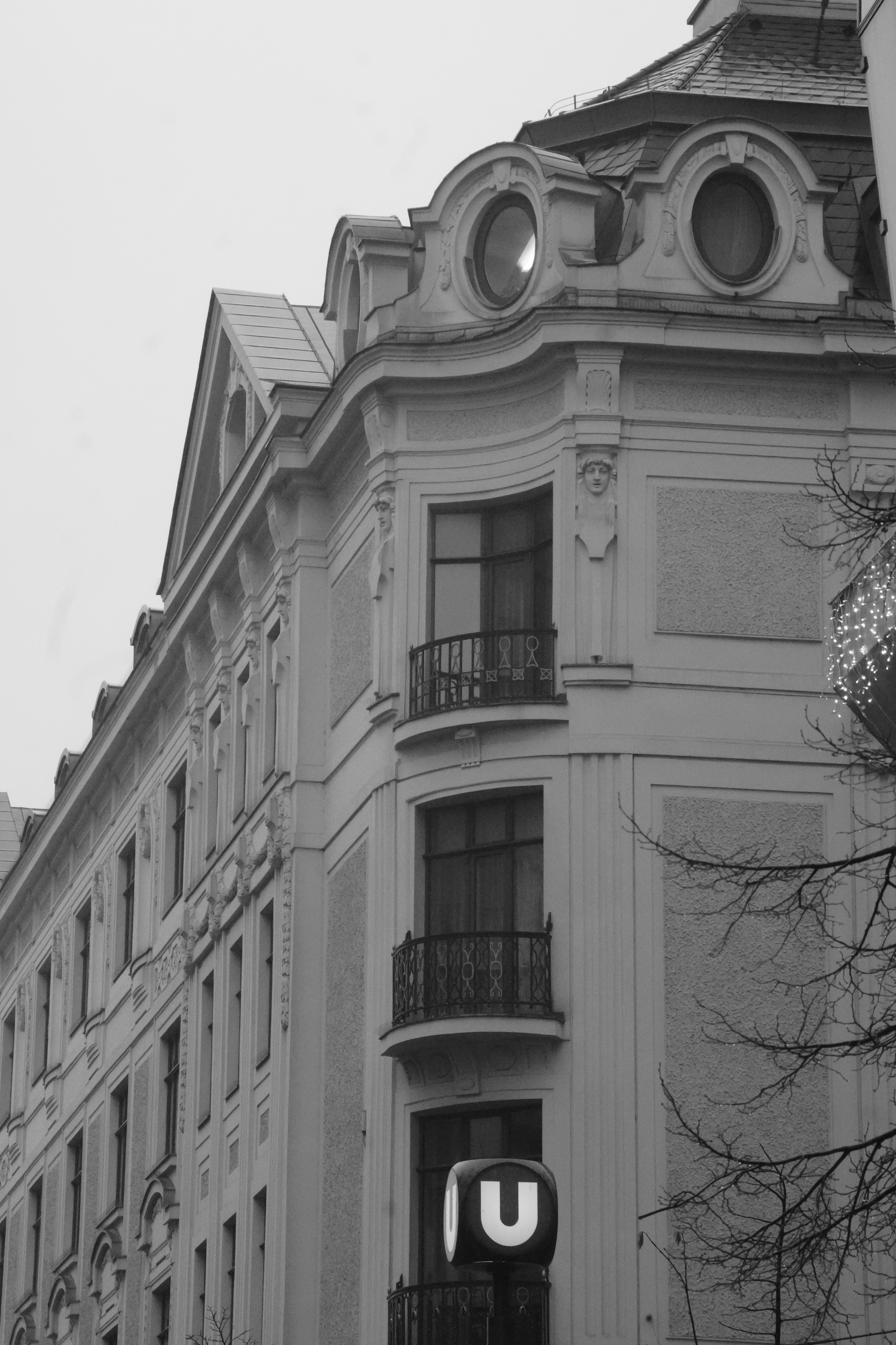 ornate European facade narrows to an illuminated U sign