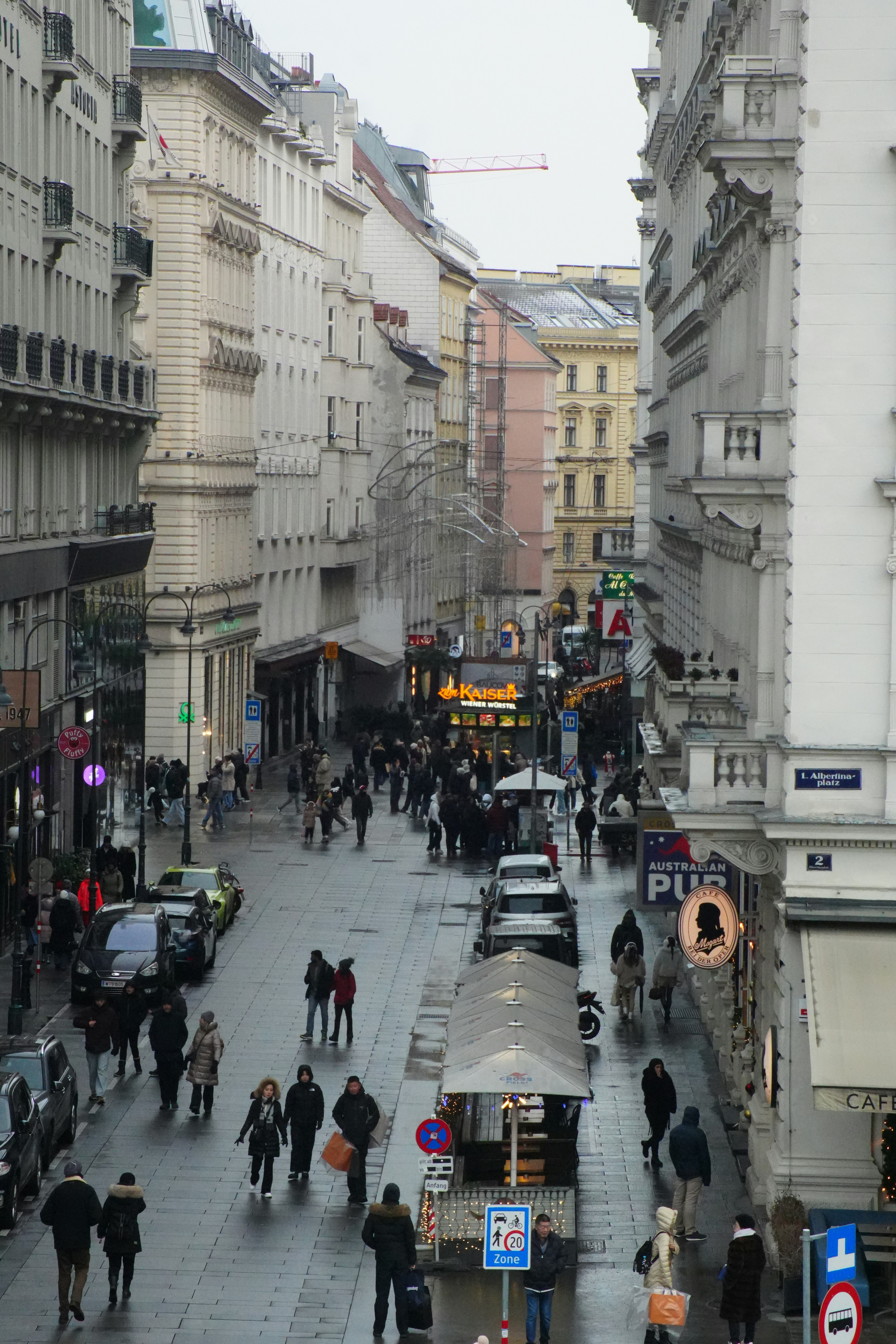 City Pulse: Pedestrians Converge Under Awned Market Canopy