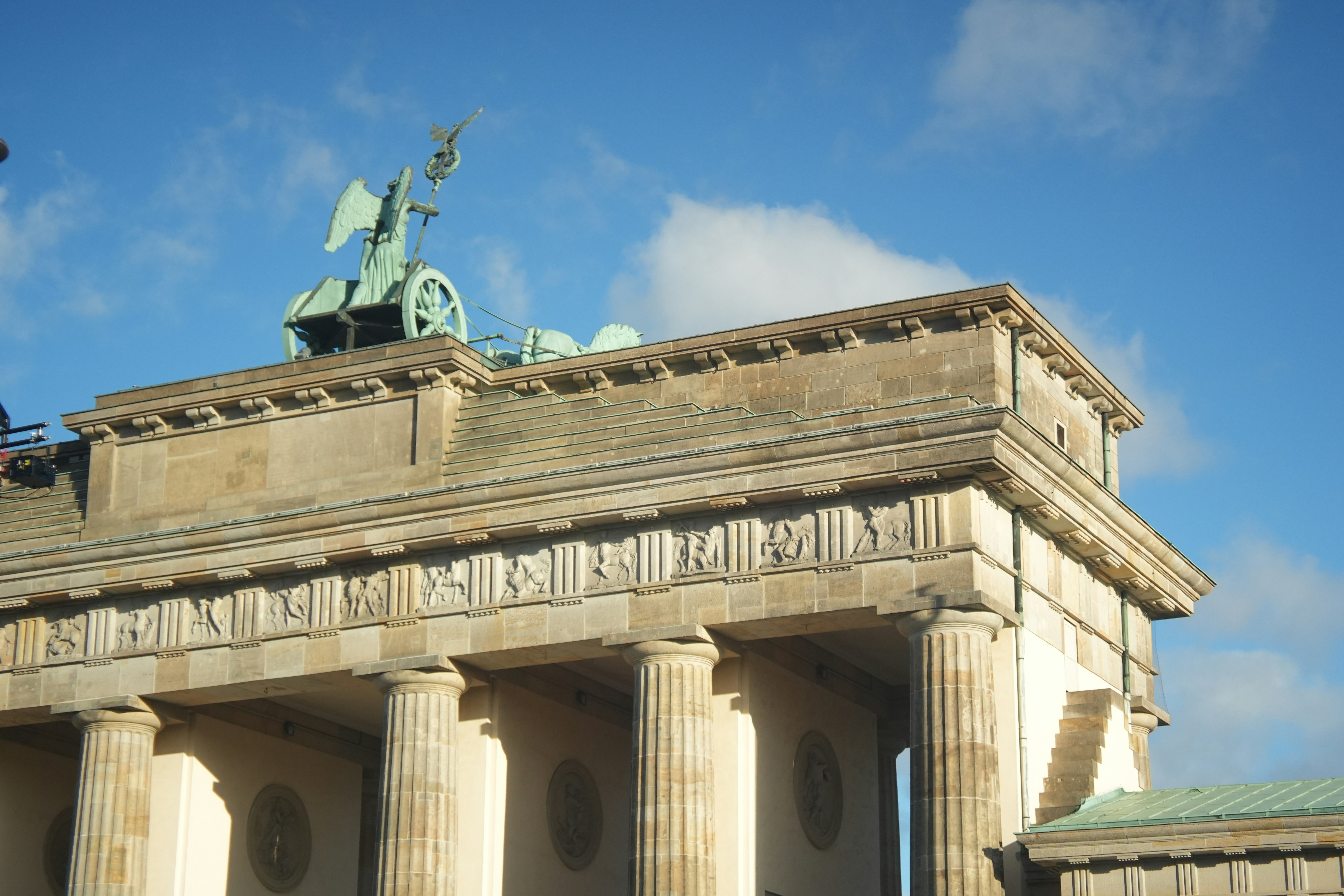 Statue atop Neoclassical Facade: Cavalry Statue Surmounting Pillars