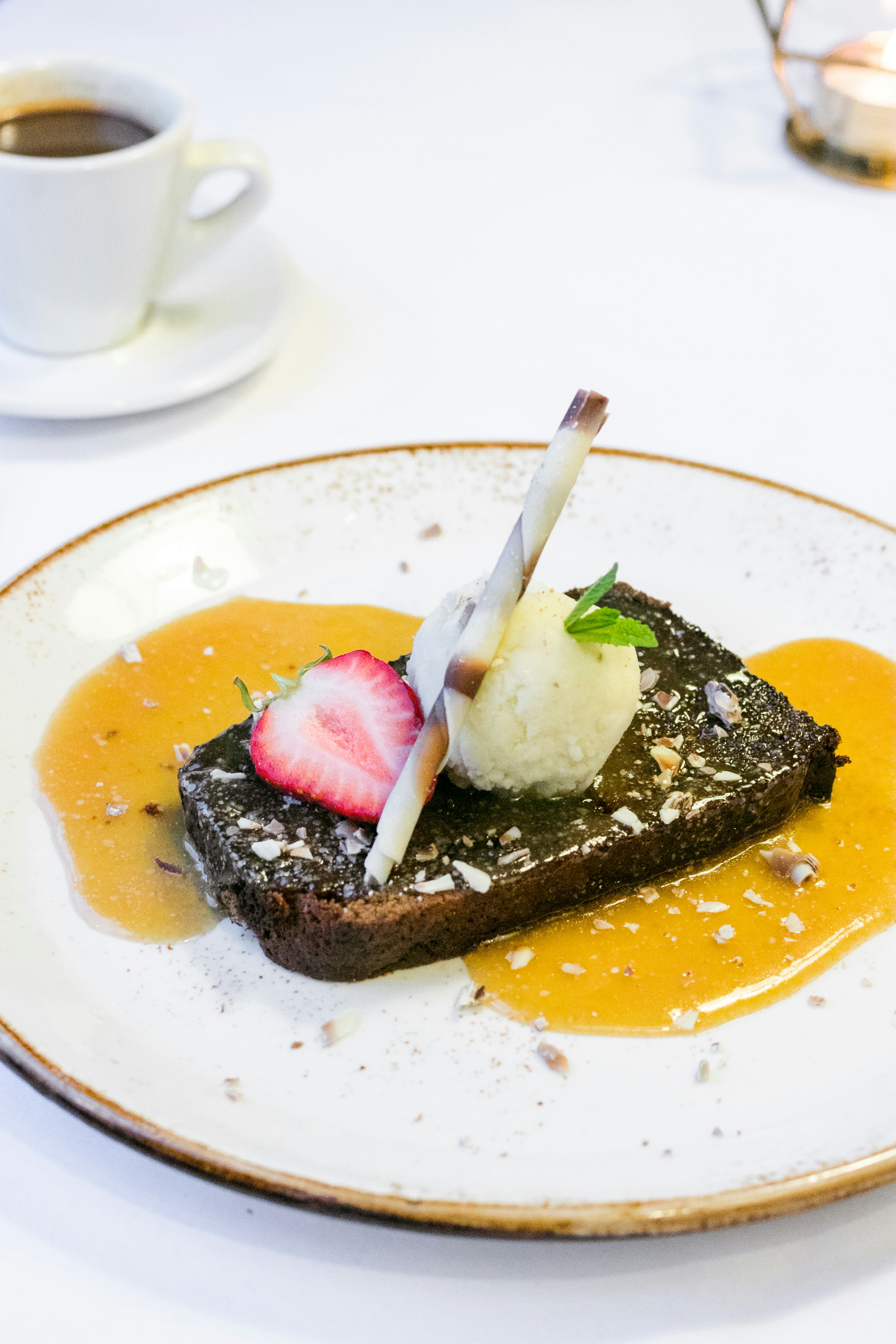 Decadent chocolate slab with citrus glaze and strawberry accent