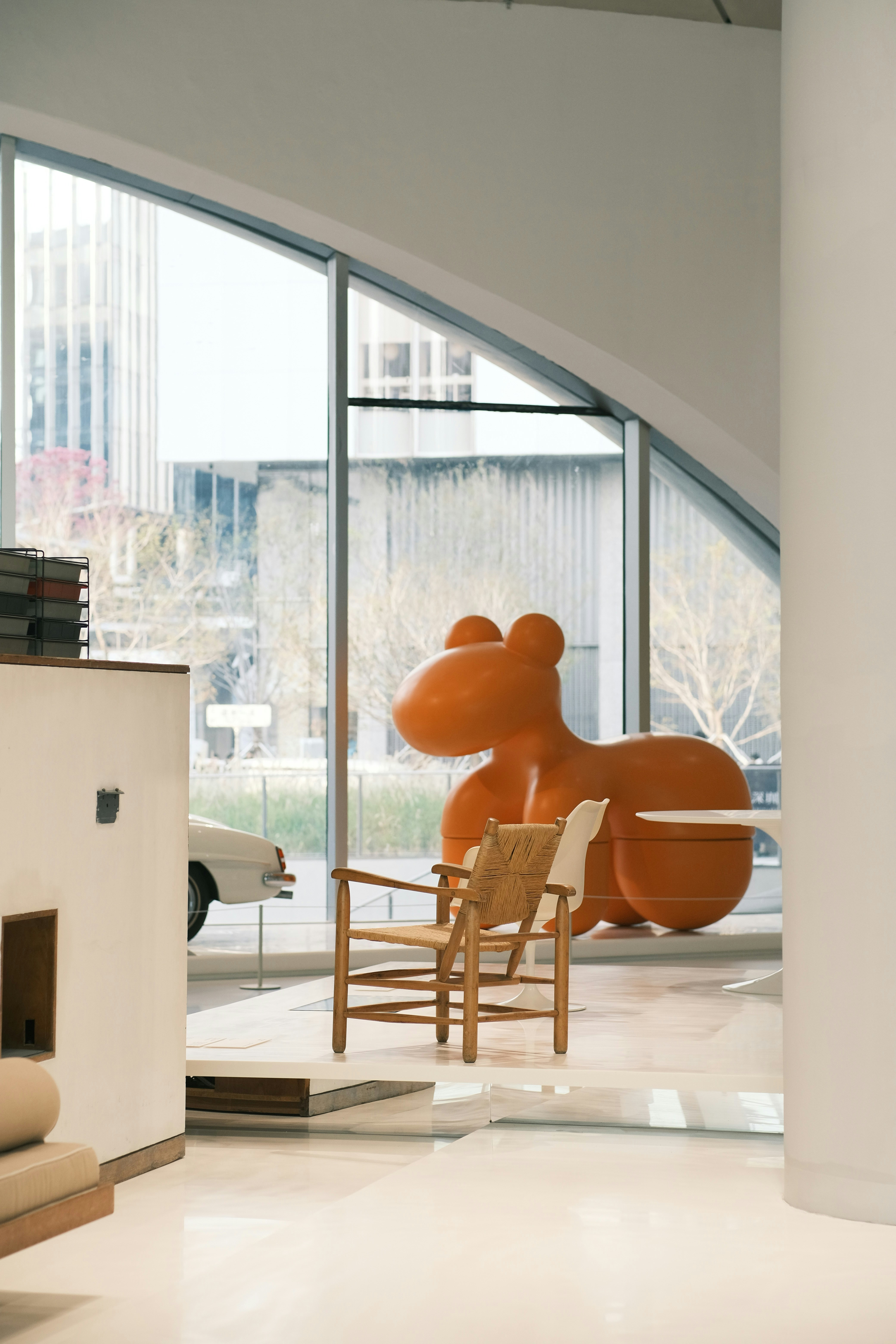 Orange Sculptural Dog in a Sunlit Modern Lobby