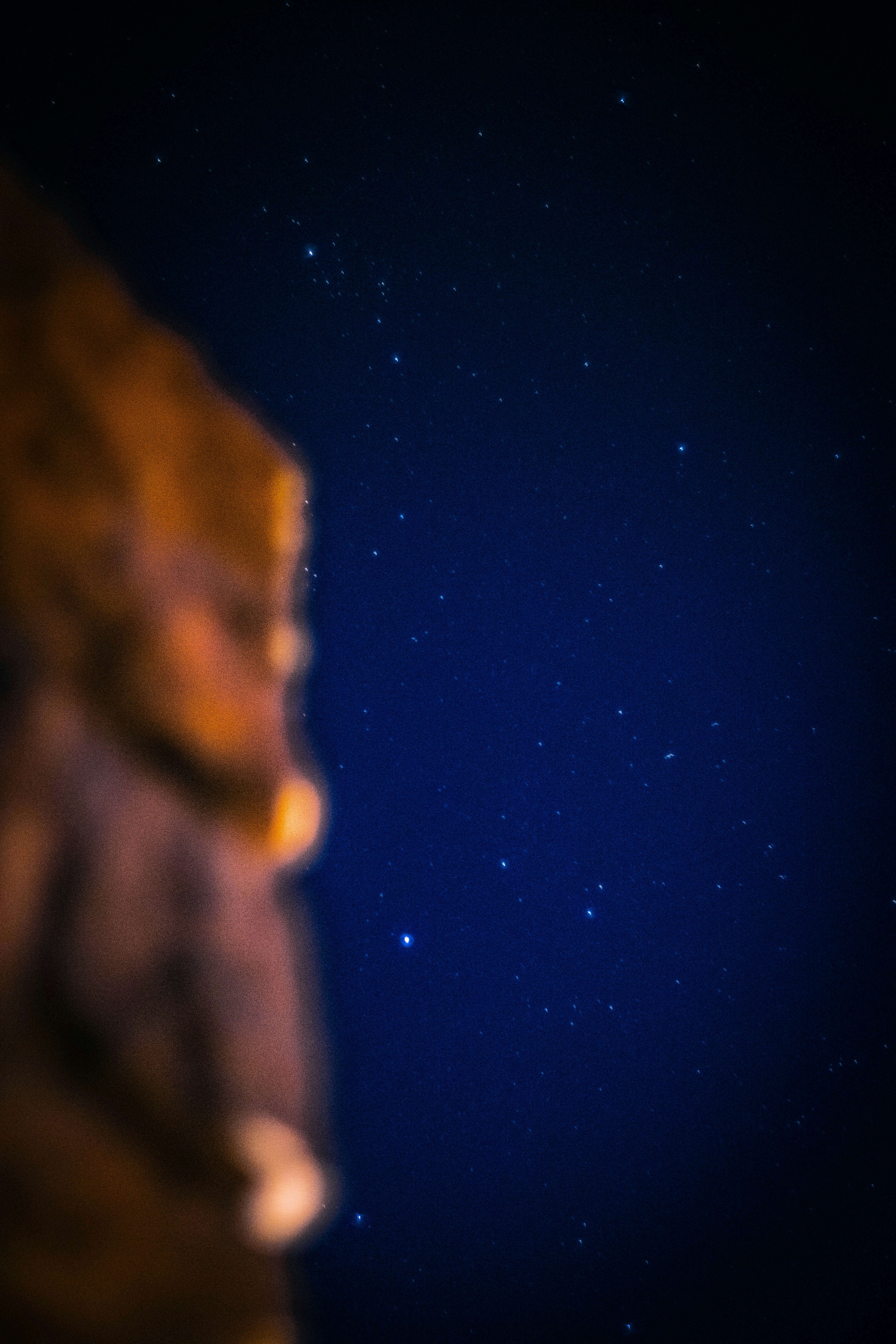 Night Sky Above a Moonlit Cliff Edge