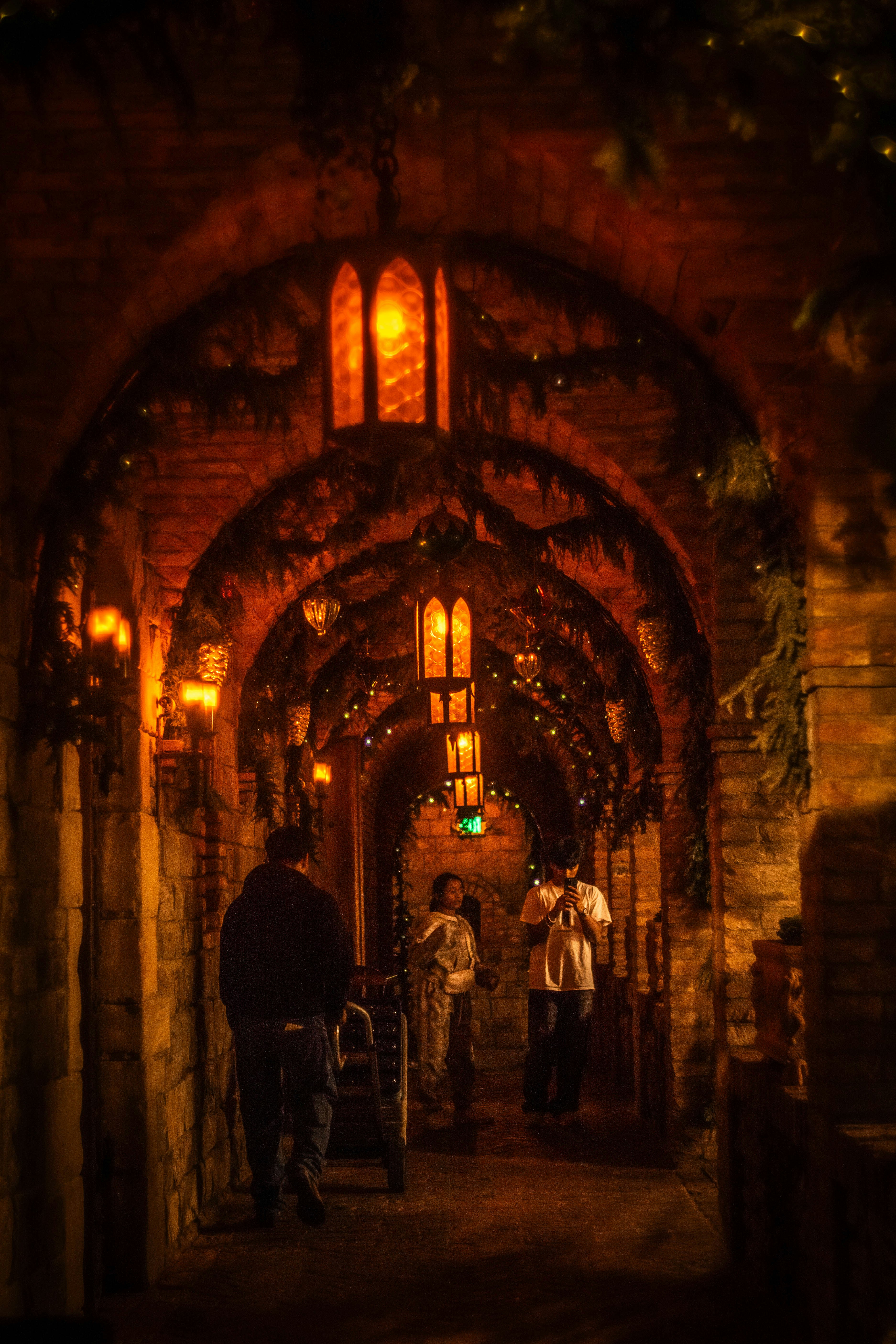 Lantern-lit Arcades: Quiet Figures in a Stone Passage