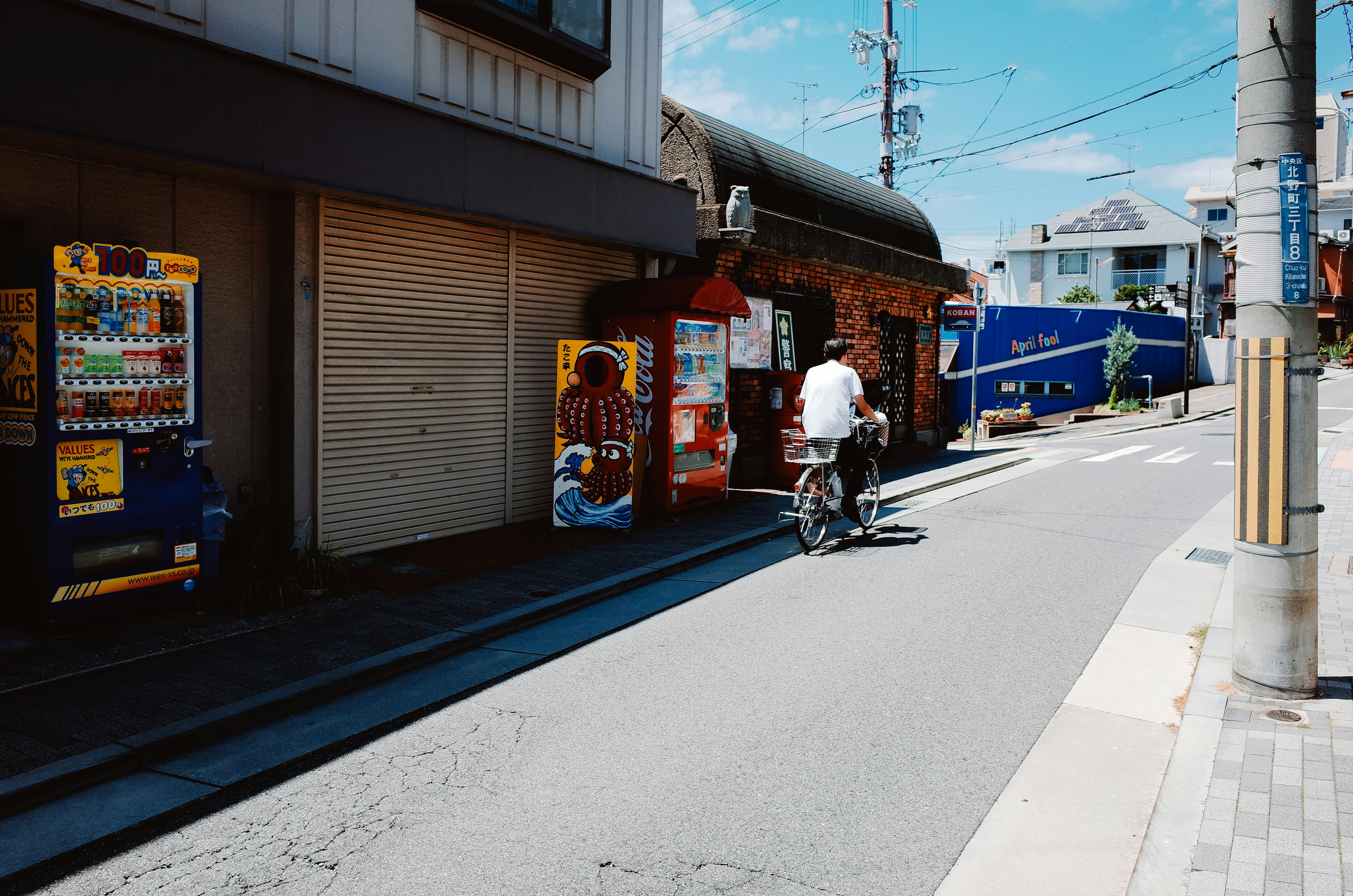 Cyclist at the Sunlit Street: A Quiet Urban Moment