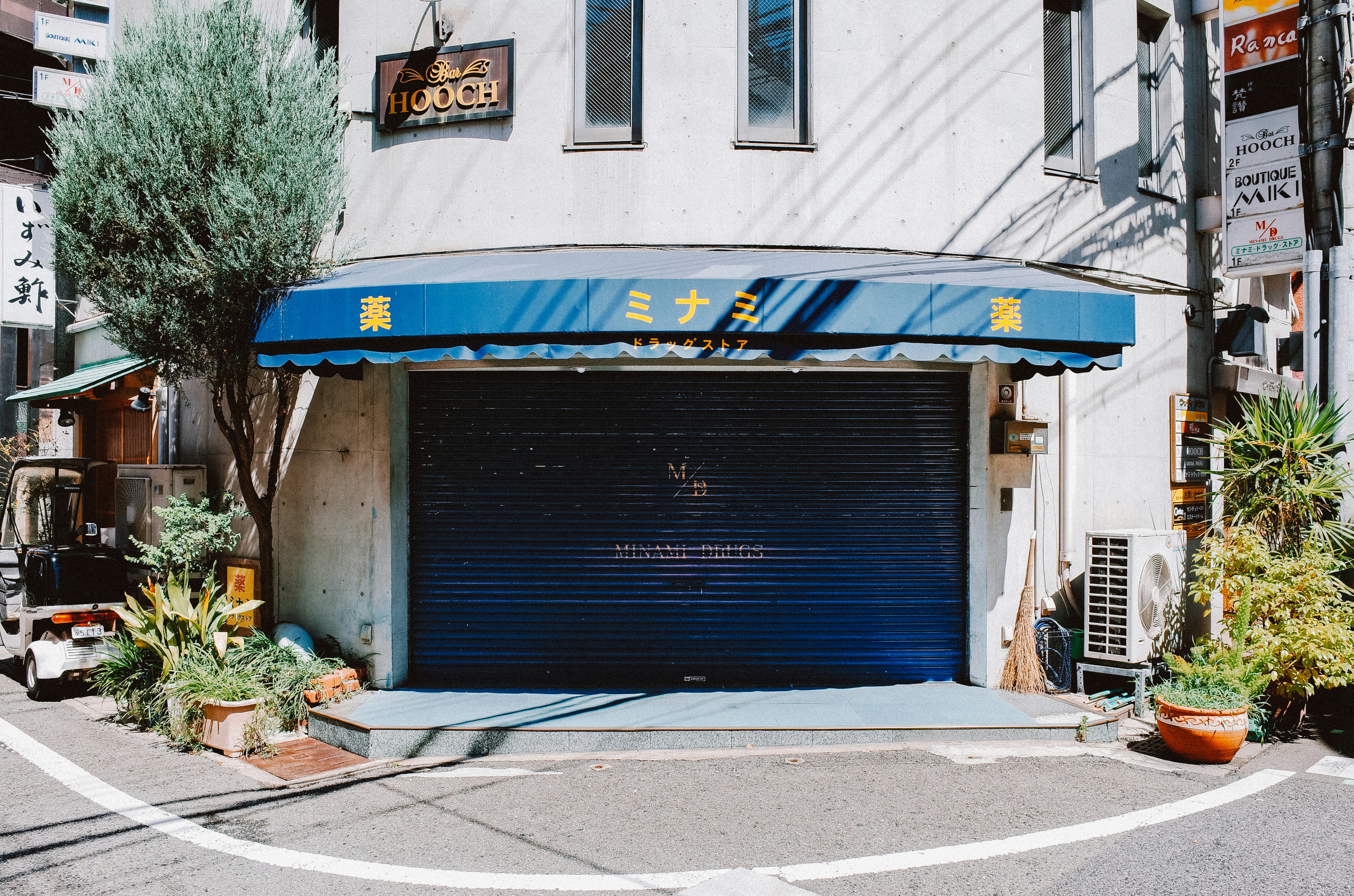 Blue Shuttered Storefront Under a Quiet Urban Awnning