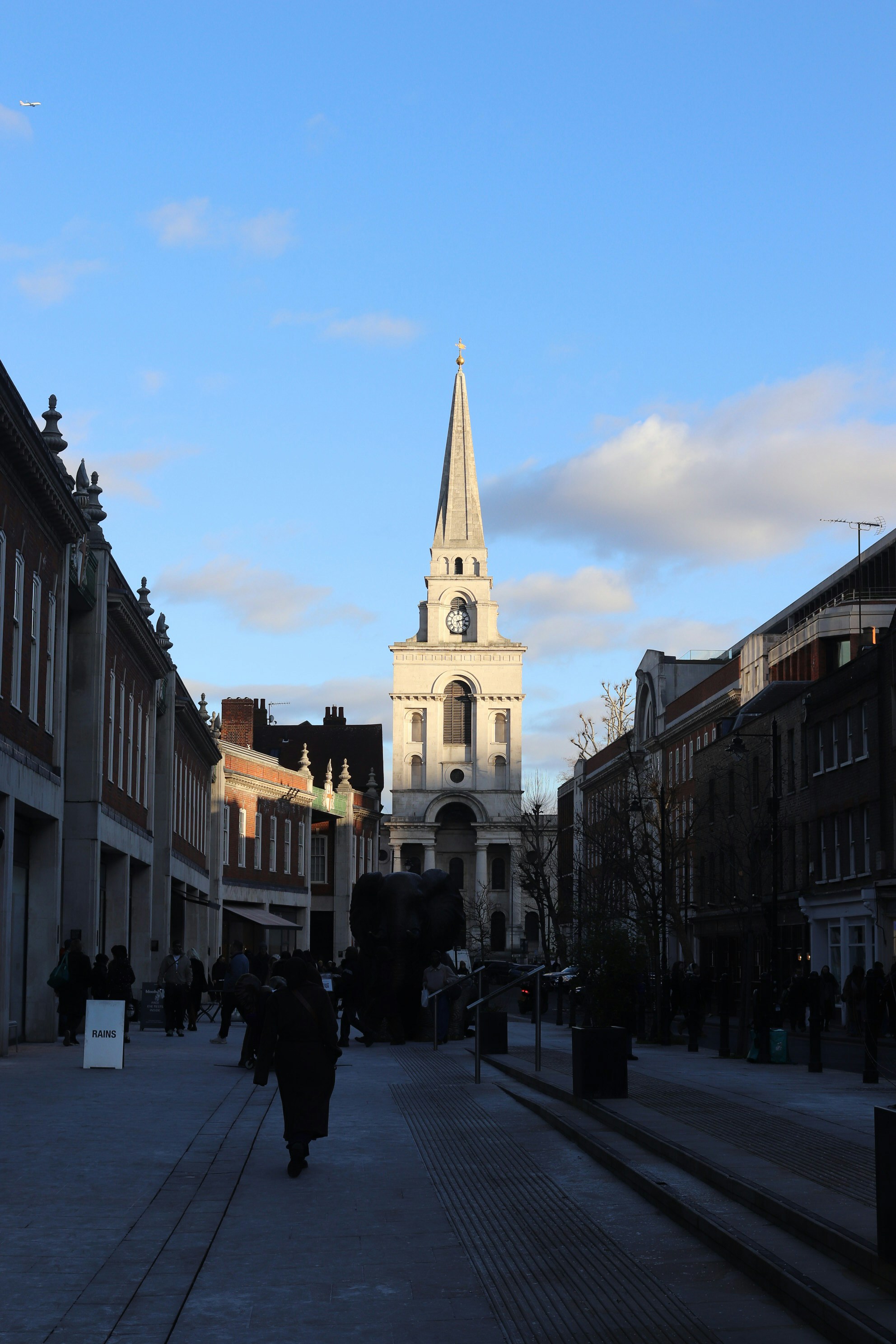 Tower in the Cross Street: A Clocktower Cathedral Rising Above a Quiet City Lane