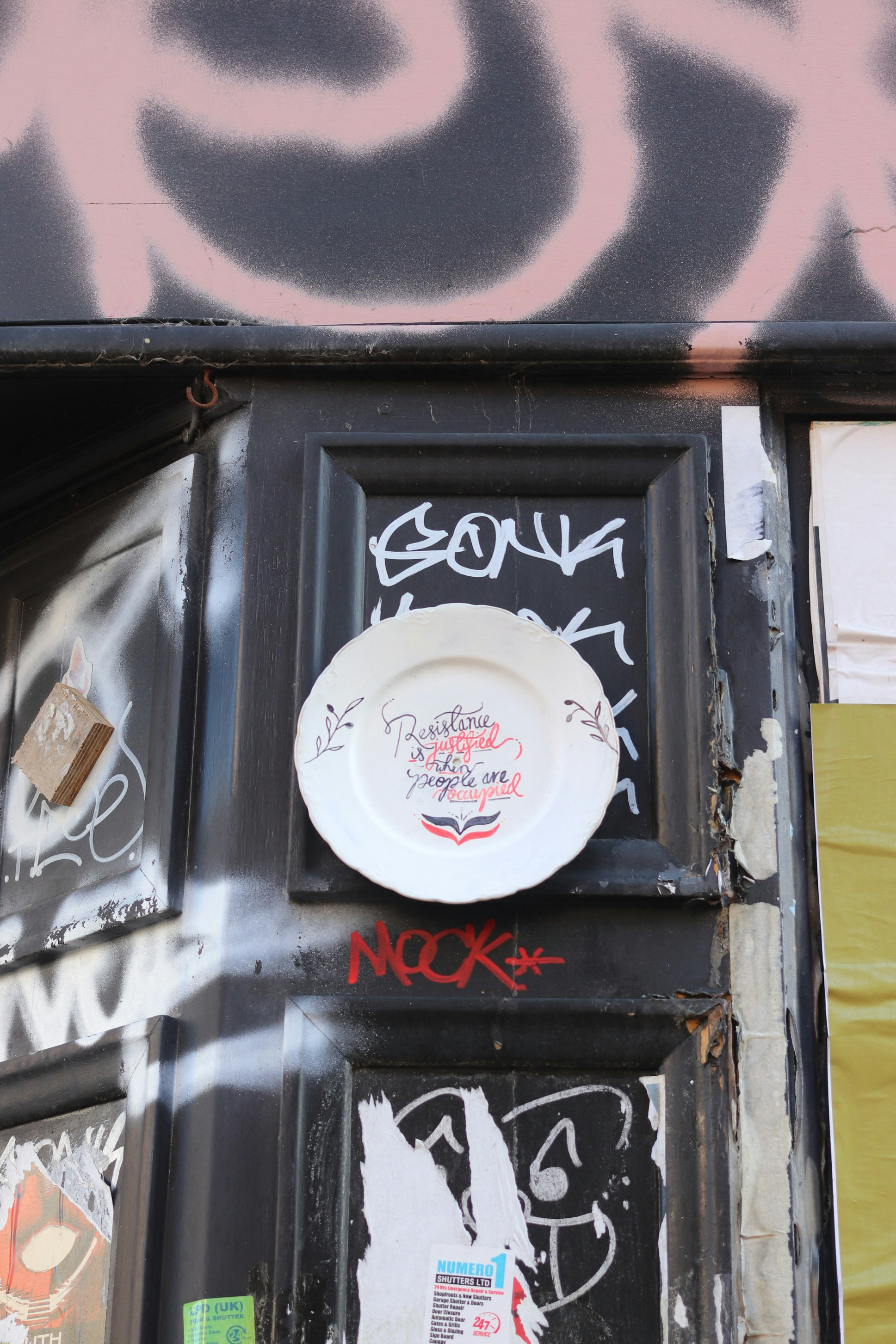 Plate with writing on graffiti-covered wall photo – Free Graffiti Image ...