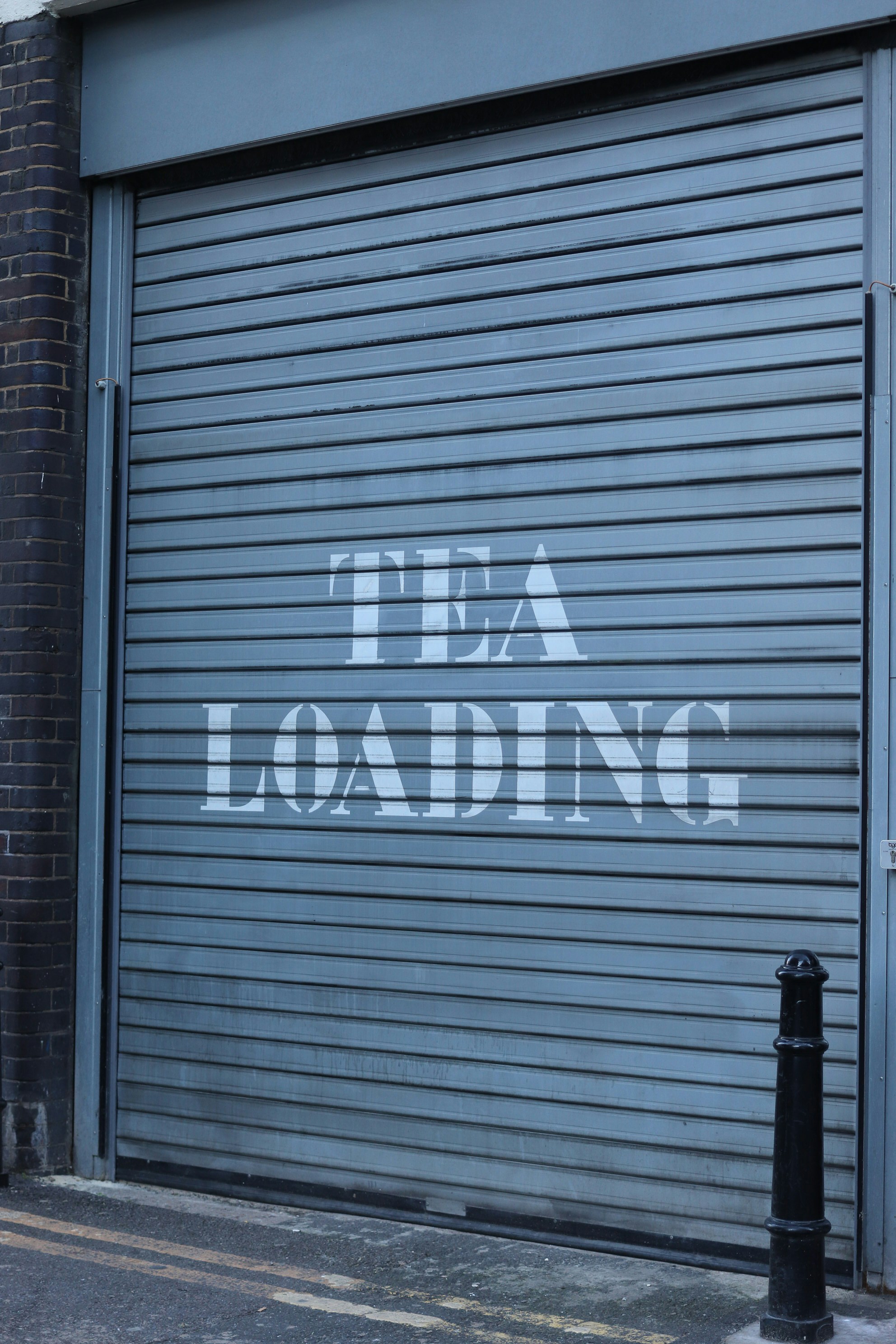 Grey metal shutter with "tea loading" text. photo – Free Tea Image on ...