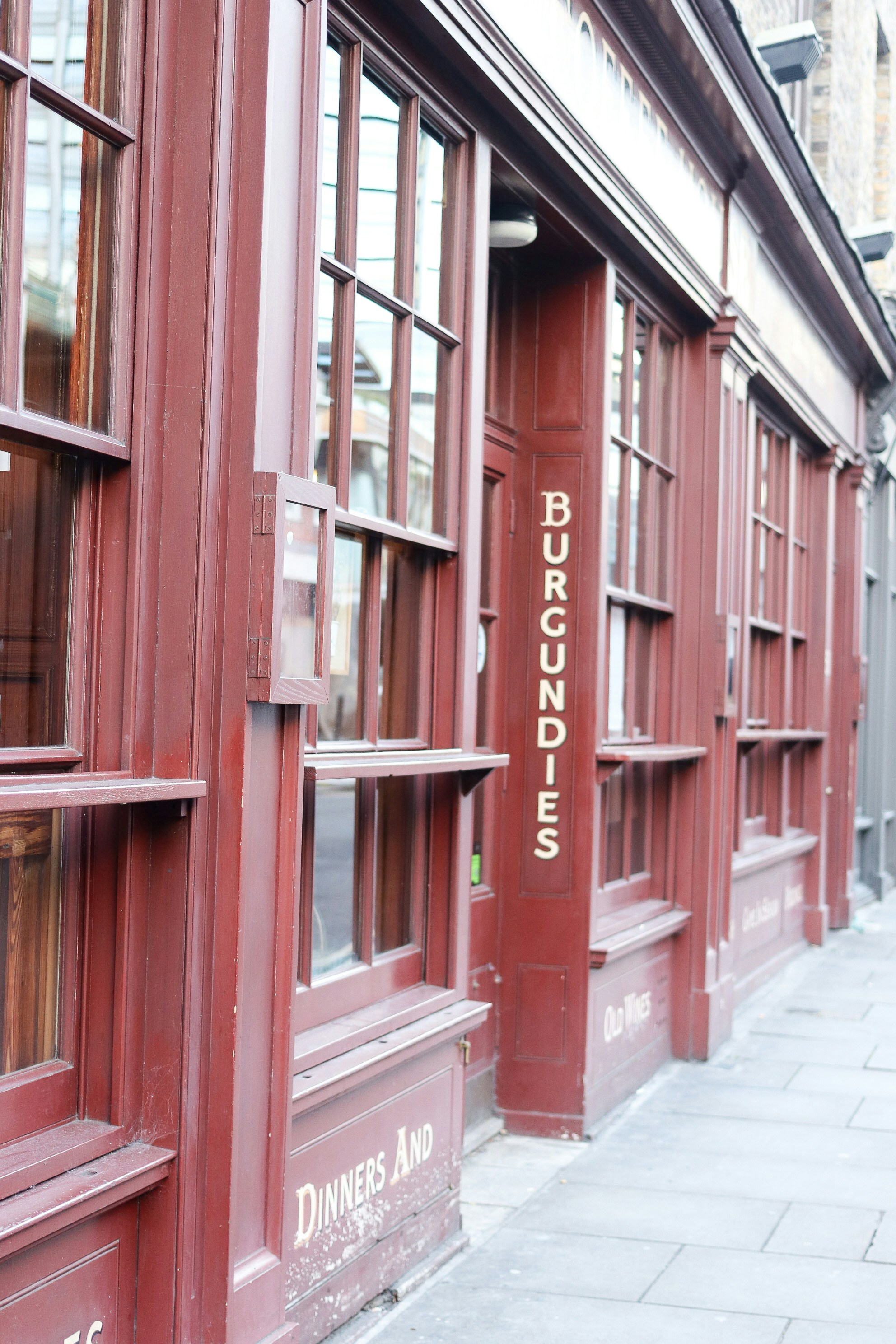 Red brick facade of a city diner beckons along a quiet street