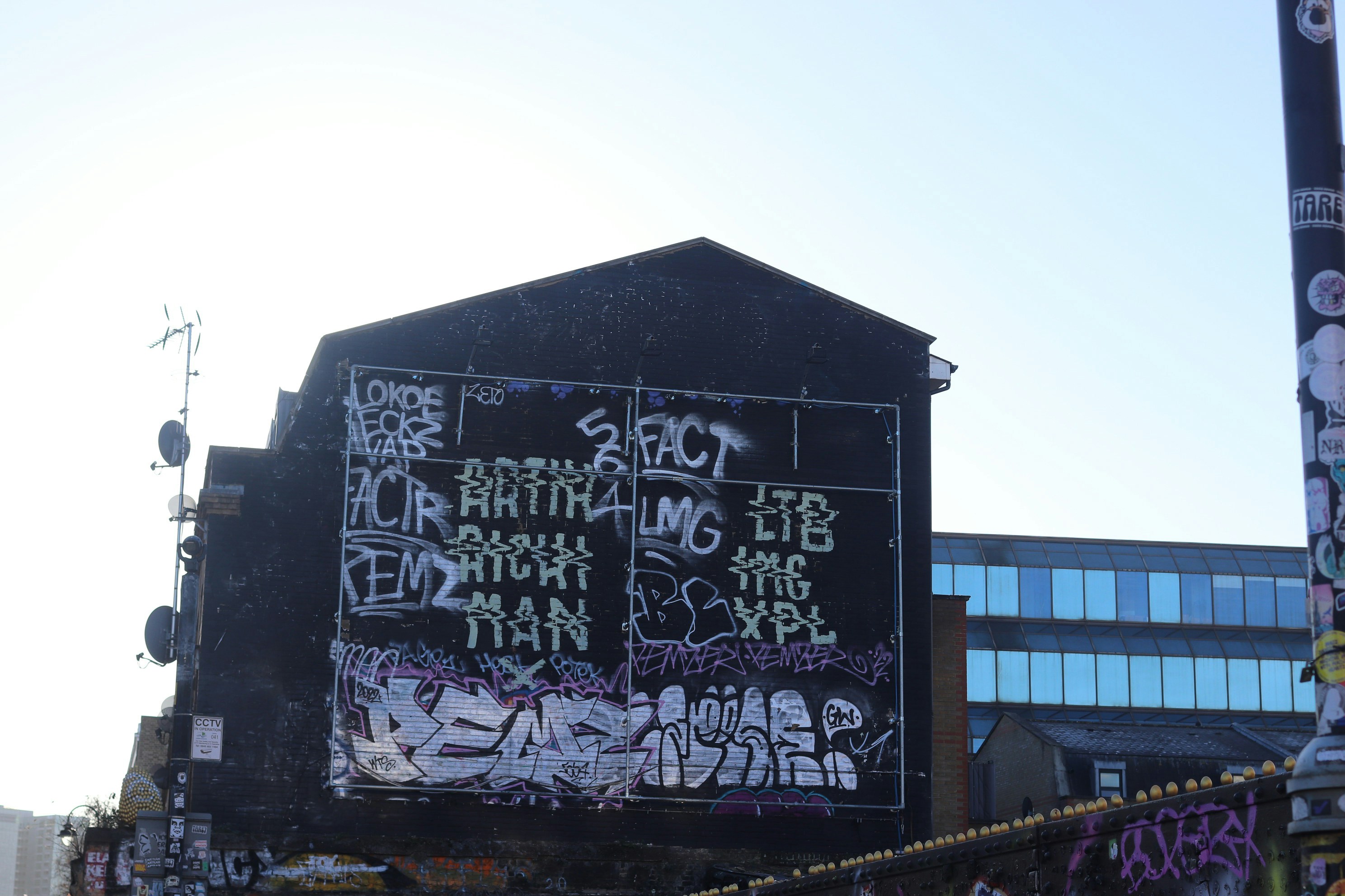 Graffiti-Graced Factory Facade Under Bright Daylight