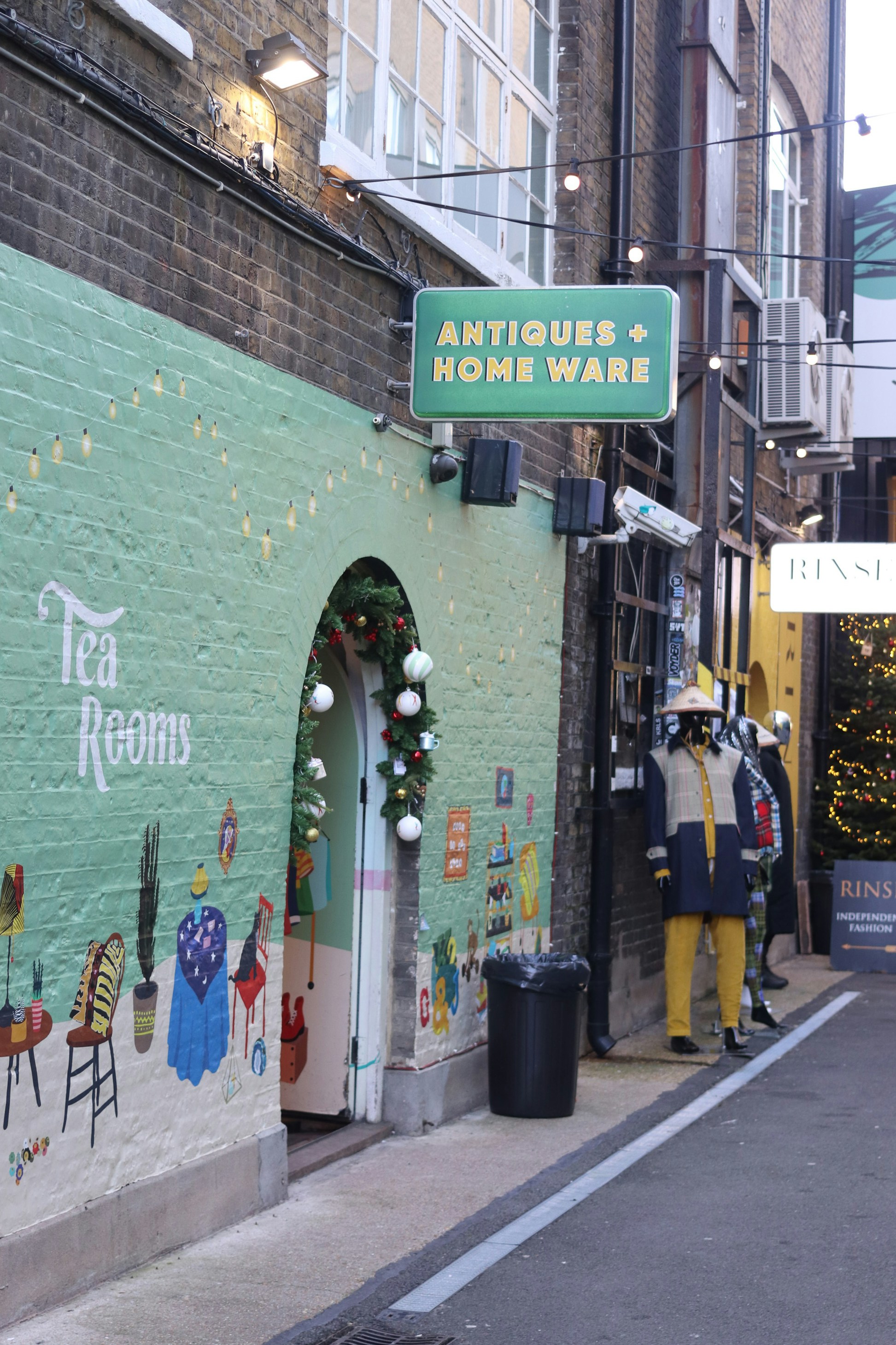 Green Wall, Warm Lights, and Vintage Vibe: A Narrow Street Scene