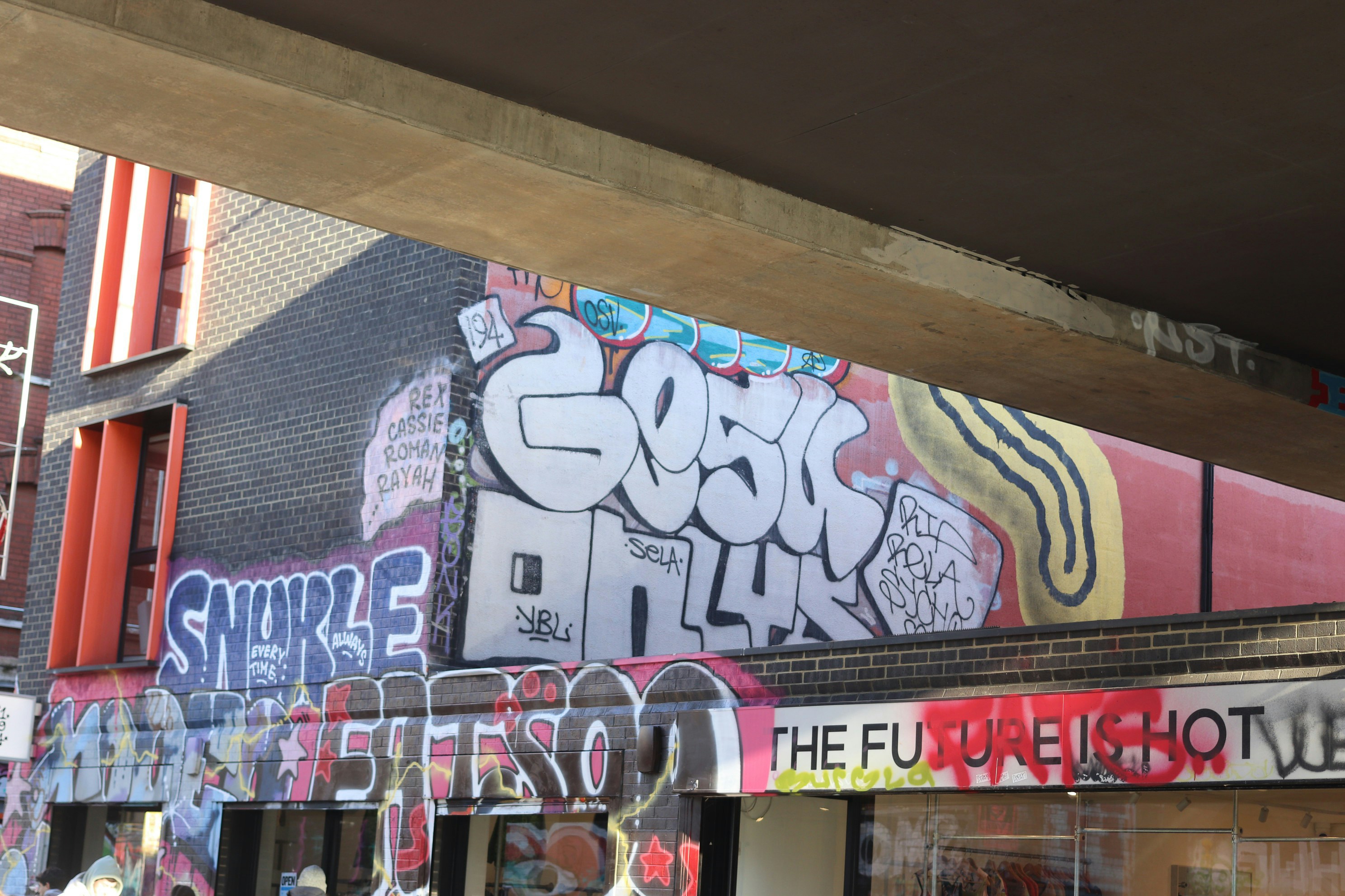 Under the Overhang: Graffiti Canvas Beneath a Concrete Beam