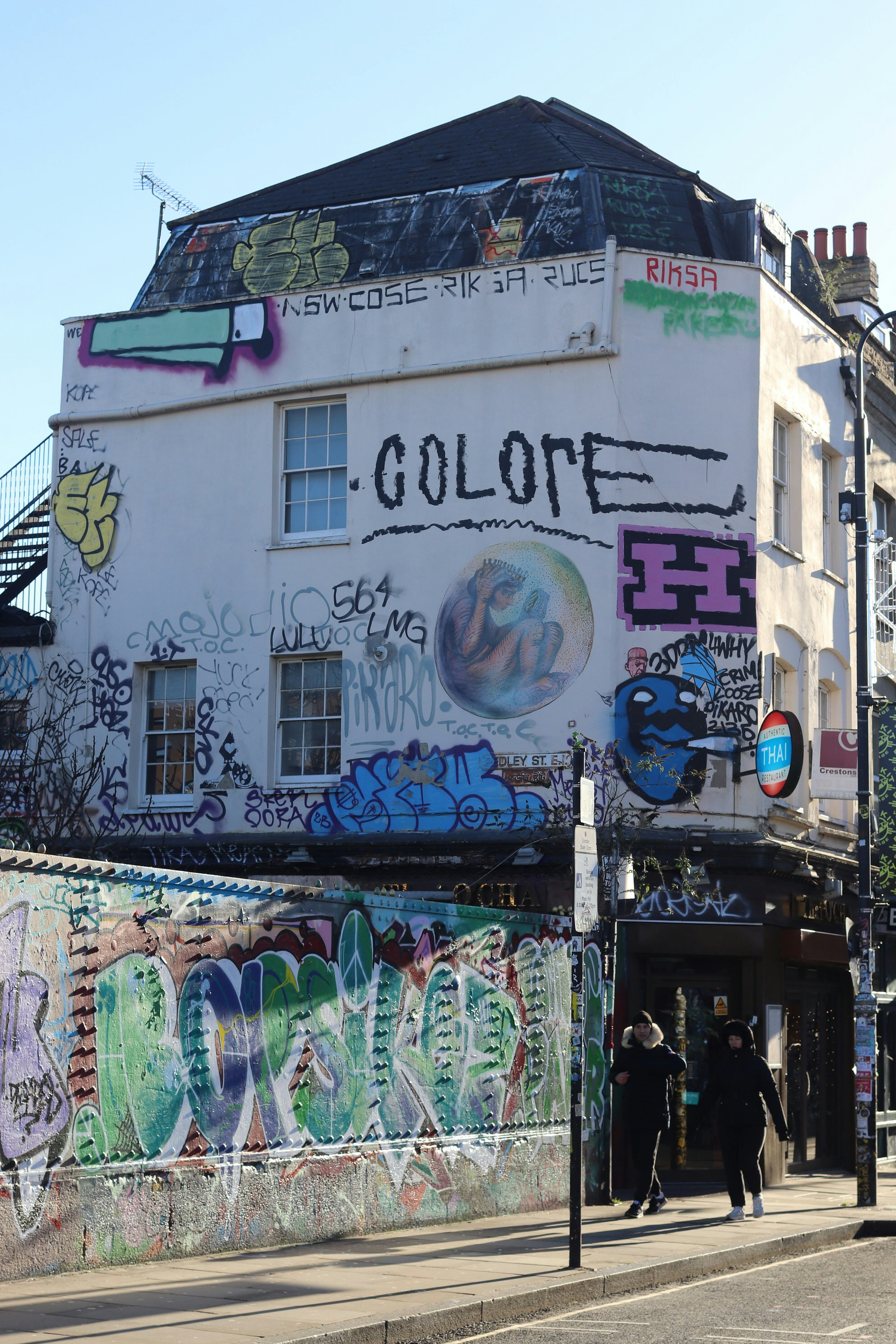 Graffitied Facade: The Colorful Corner of City Wall