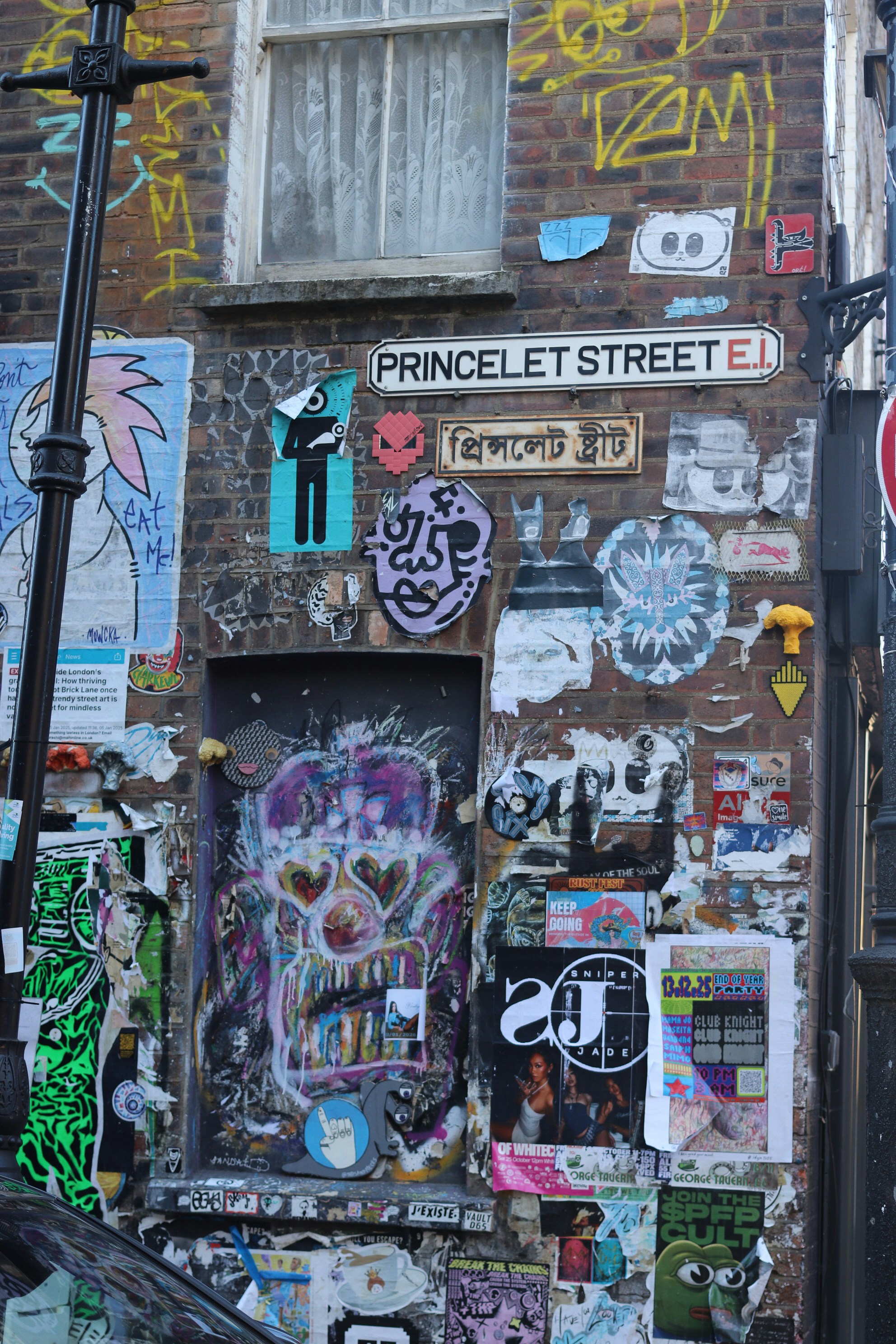 Street Wall Mosaic: A Kaleidoscope of Graffiti and Posters on Princelet Street