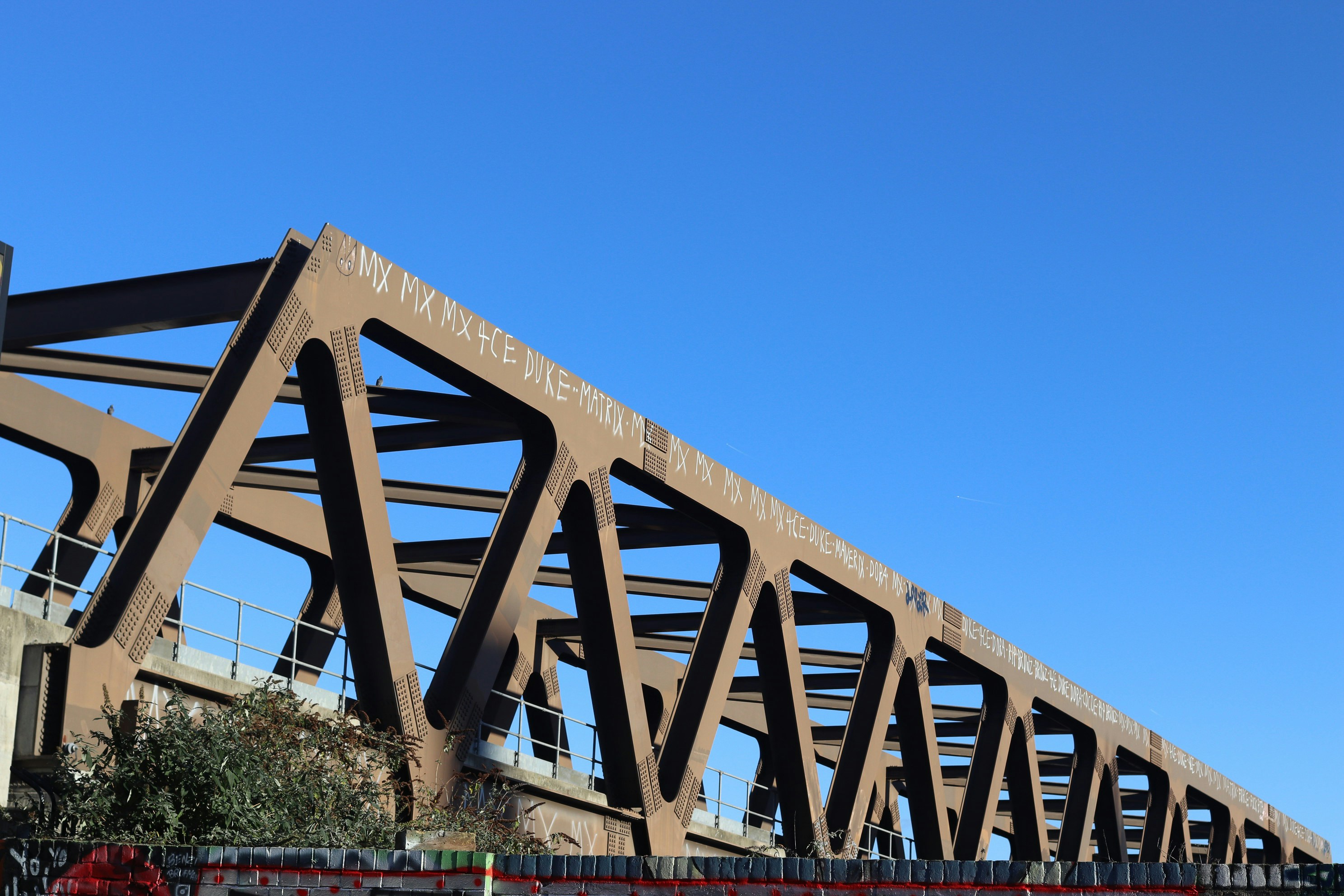 Steel Lattice Over Blue: Morning Light on a Truss Bridge