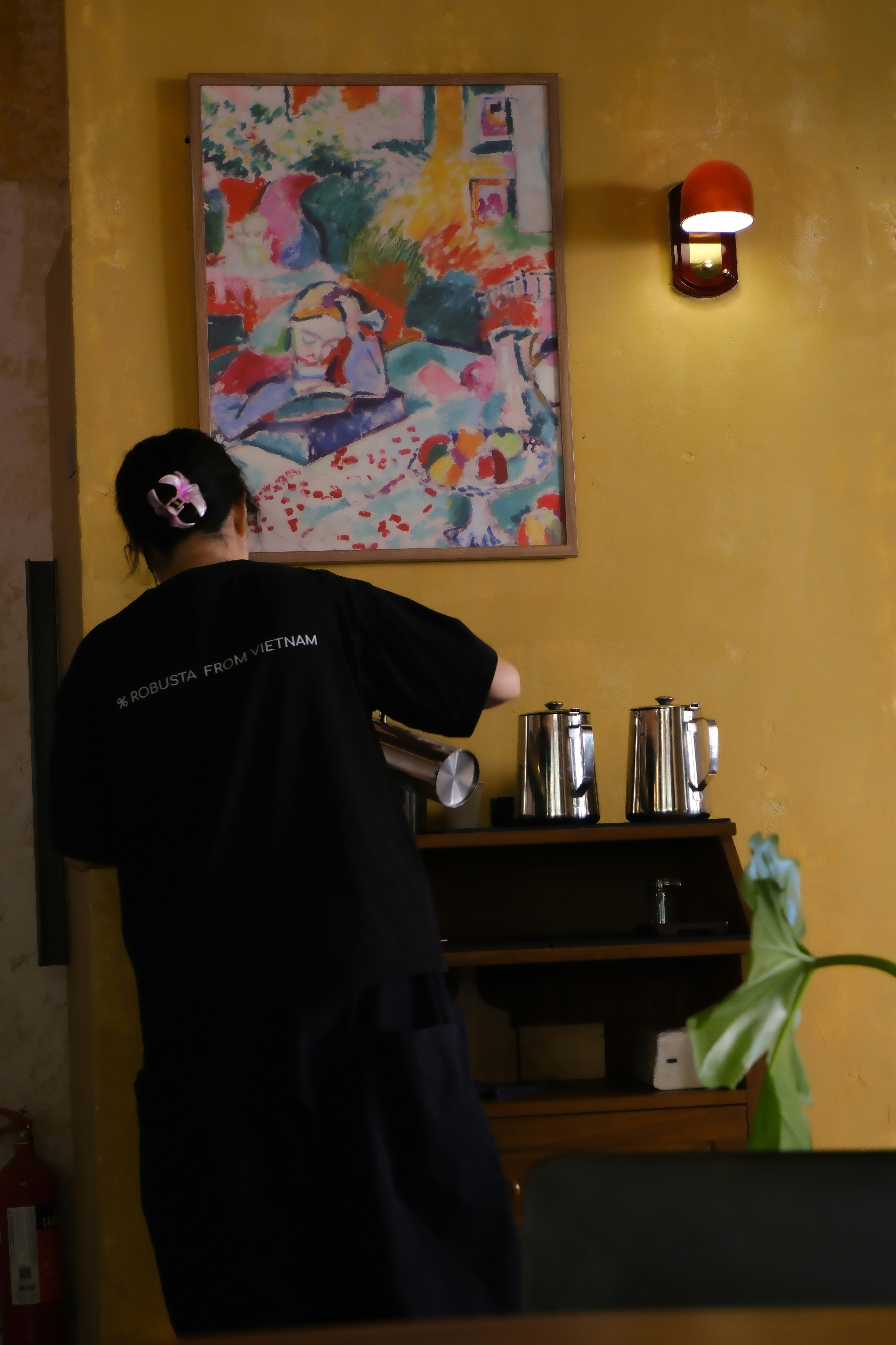 Studio Barista: a yellow-walled corner with a focused barista at work