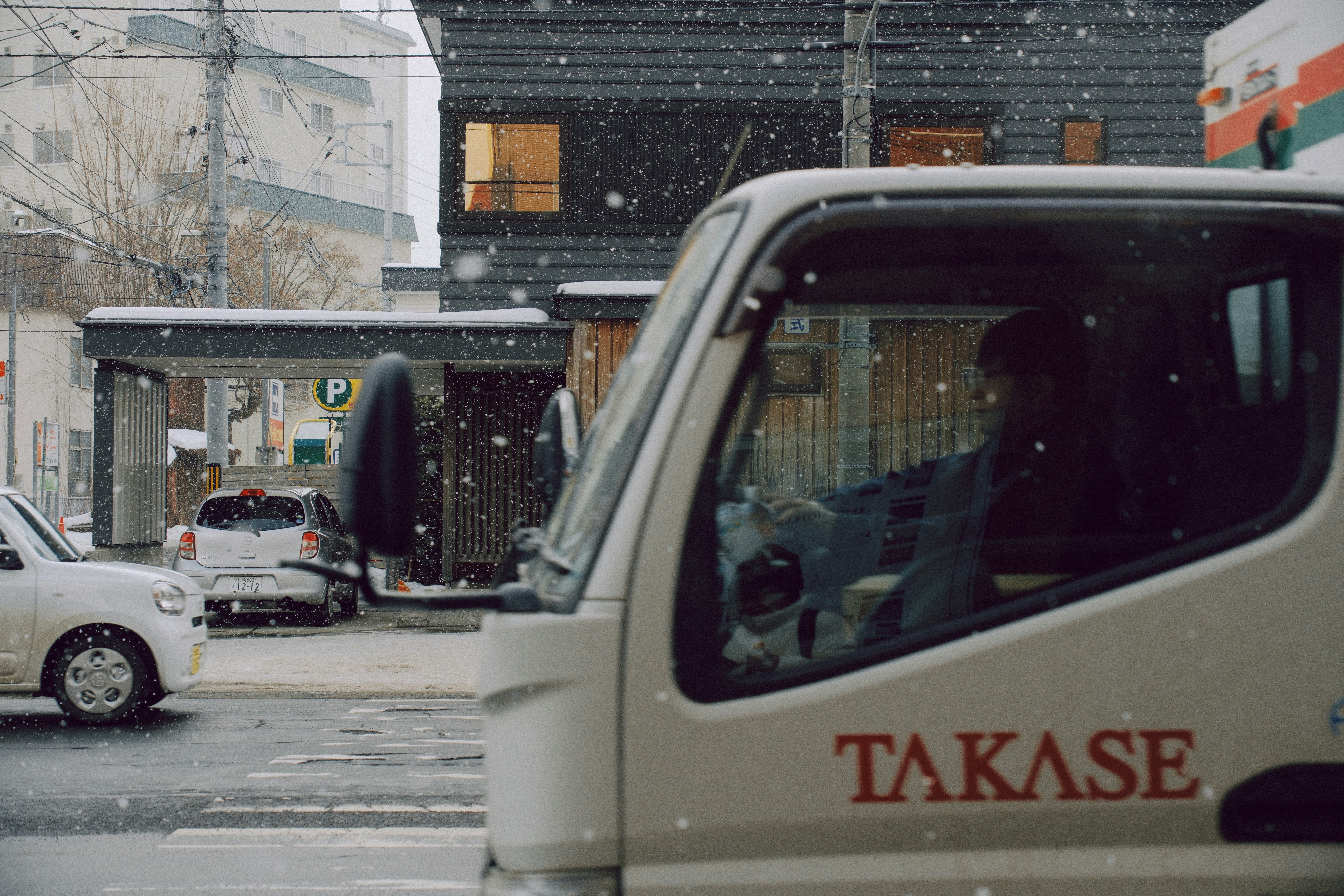 Windowed Driver in a Snowy City Lane