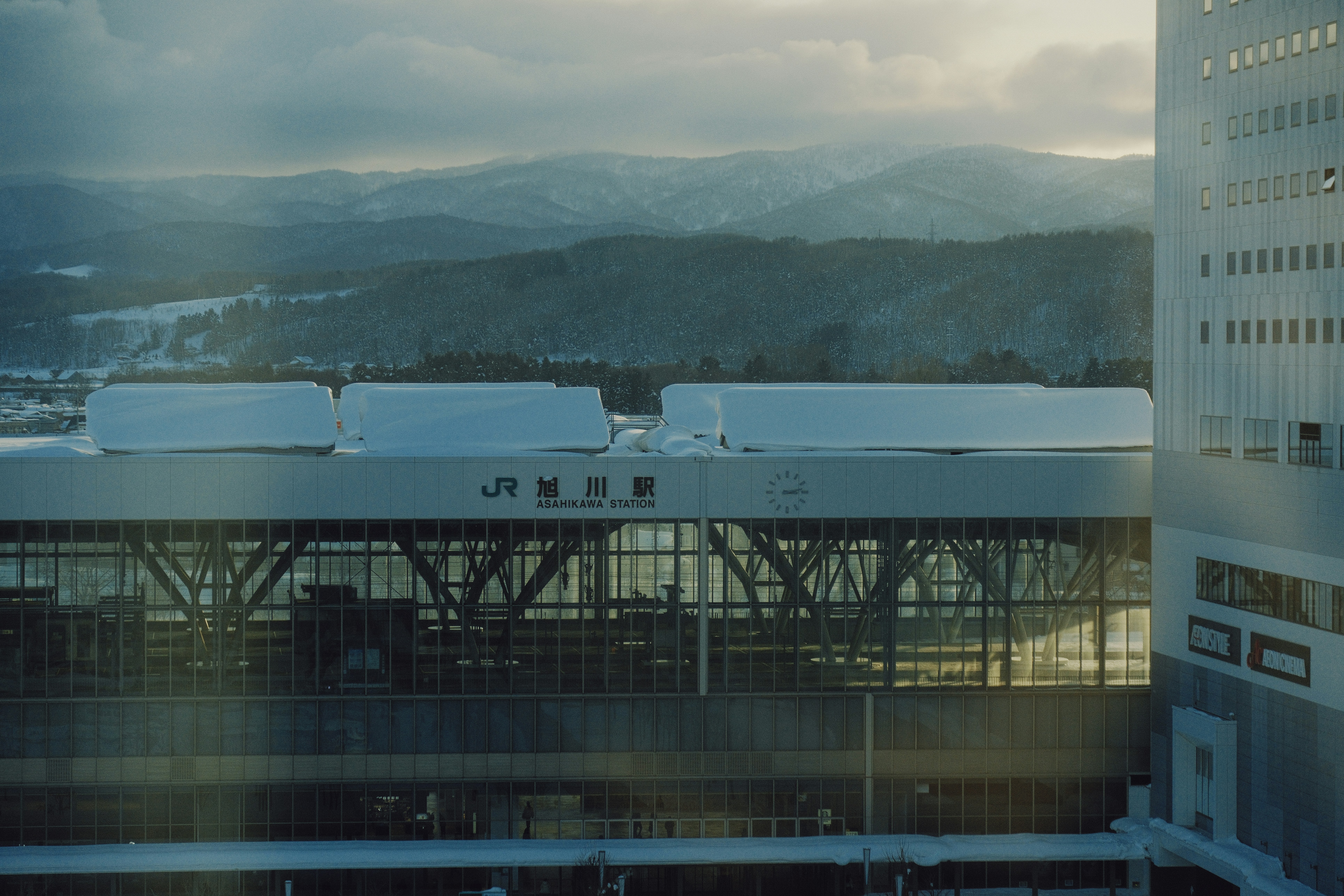 Station Horizon: Snow-Capped Rails Beyond Glass Facades