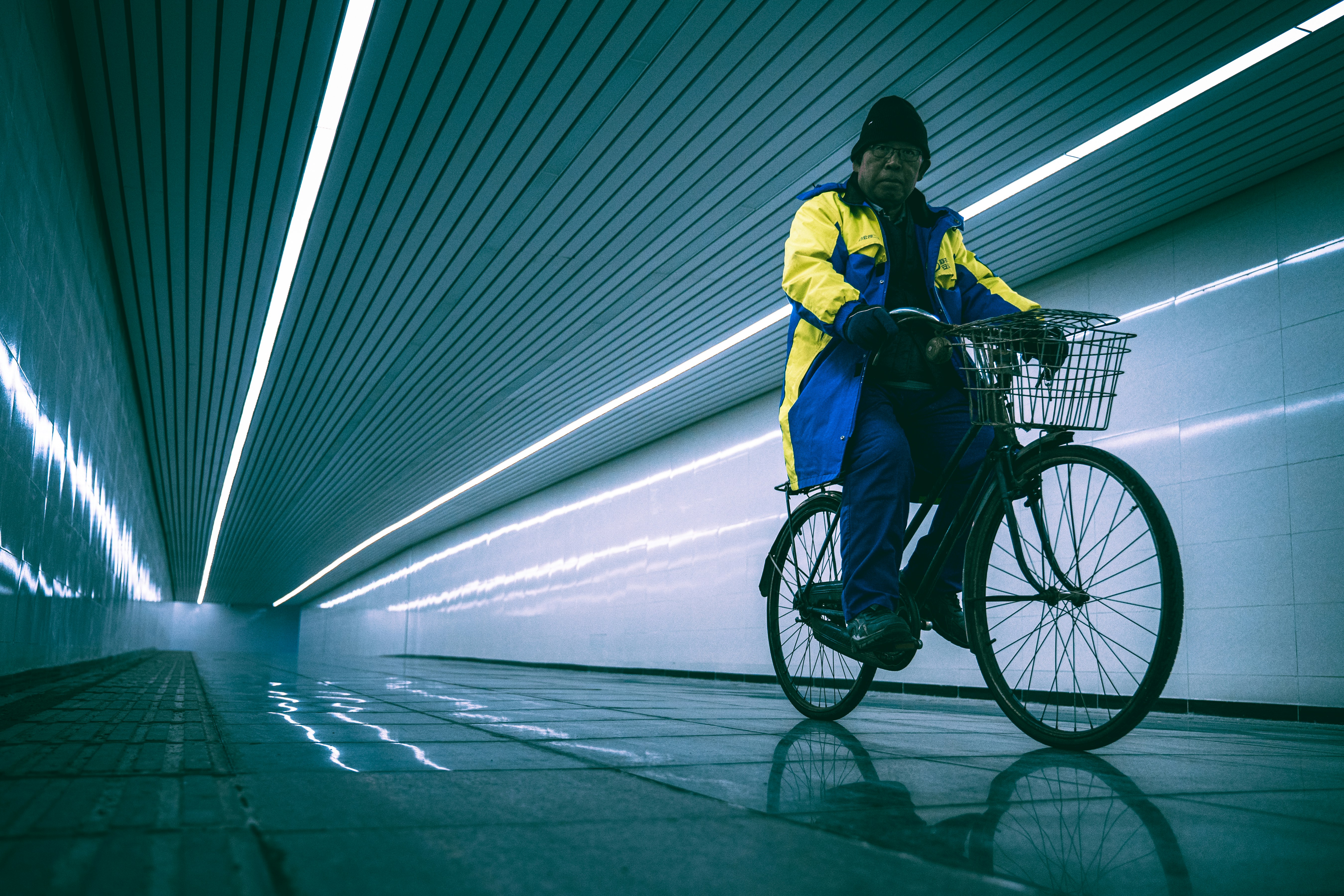 Cyclist in a Neon-Blue Tunnel: A City Ride Through Light and Motion