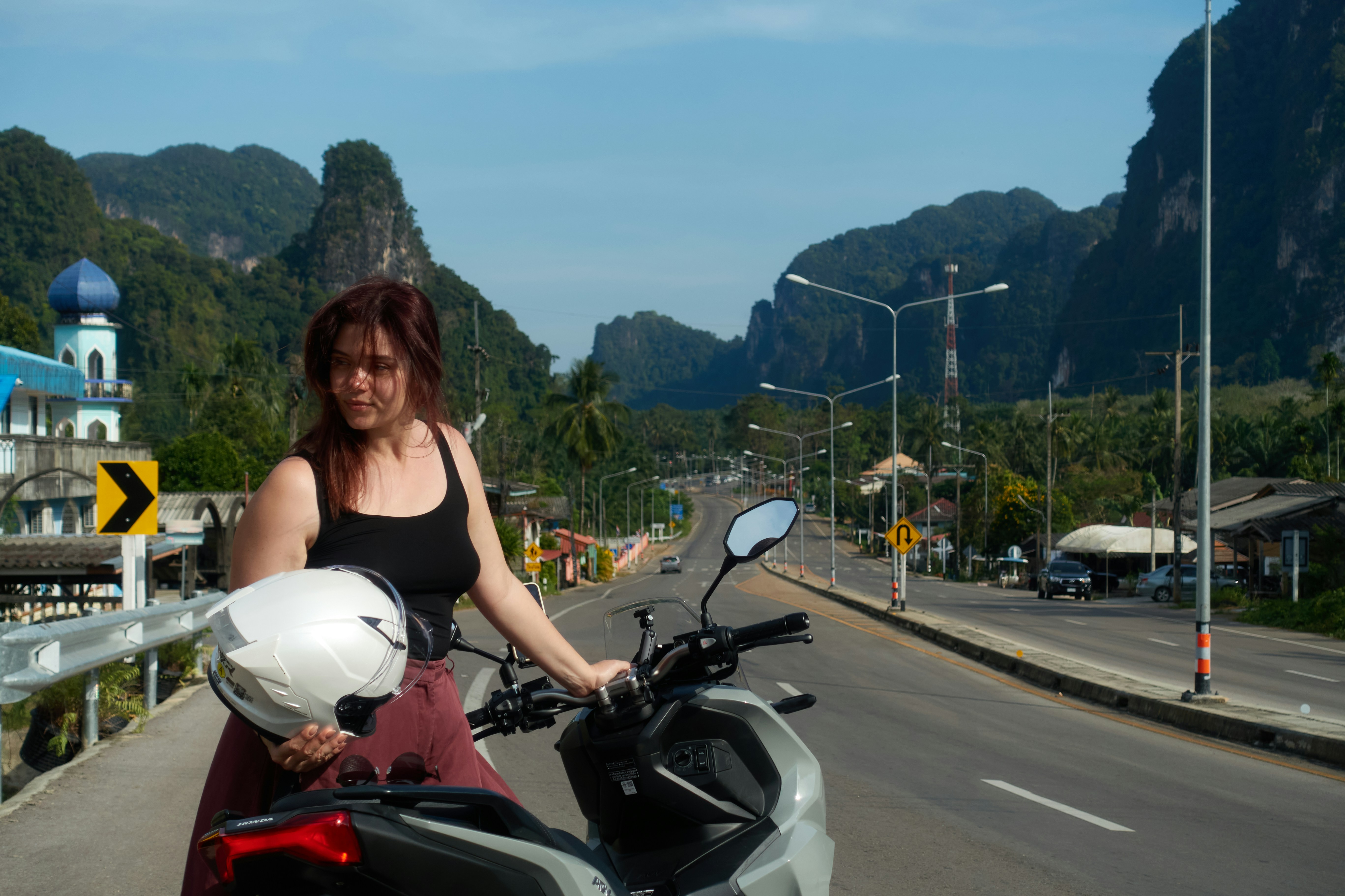 Rider Pauses with Helmet in Hand as Mountain Township Opens Up