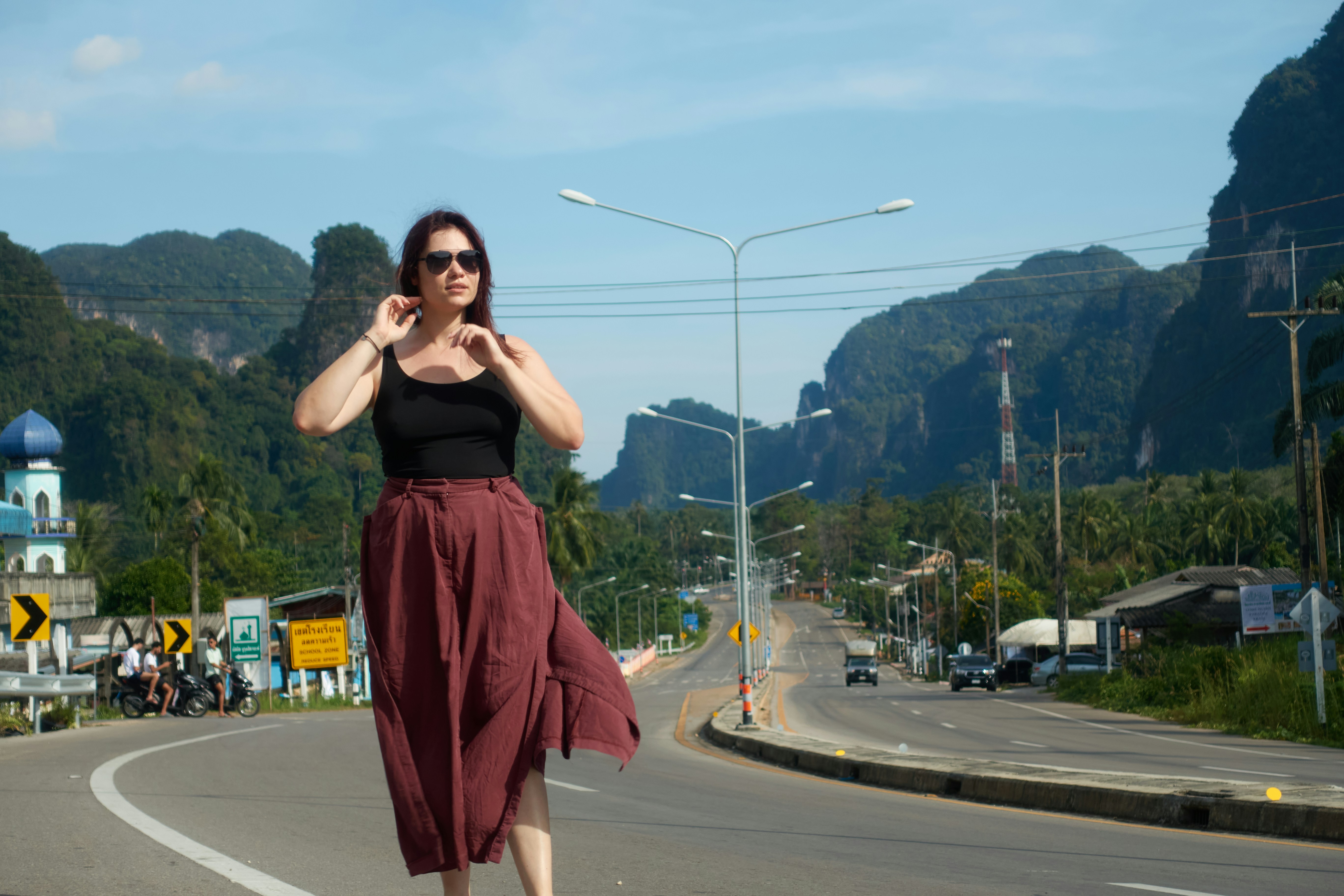 Stride through the coastal boulevard: a confident wanderer steps into the open road