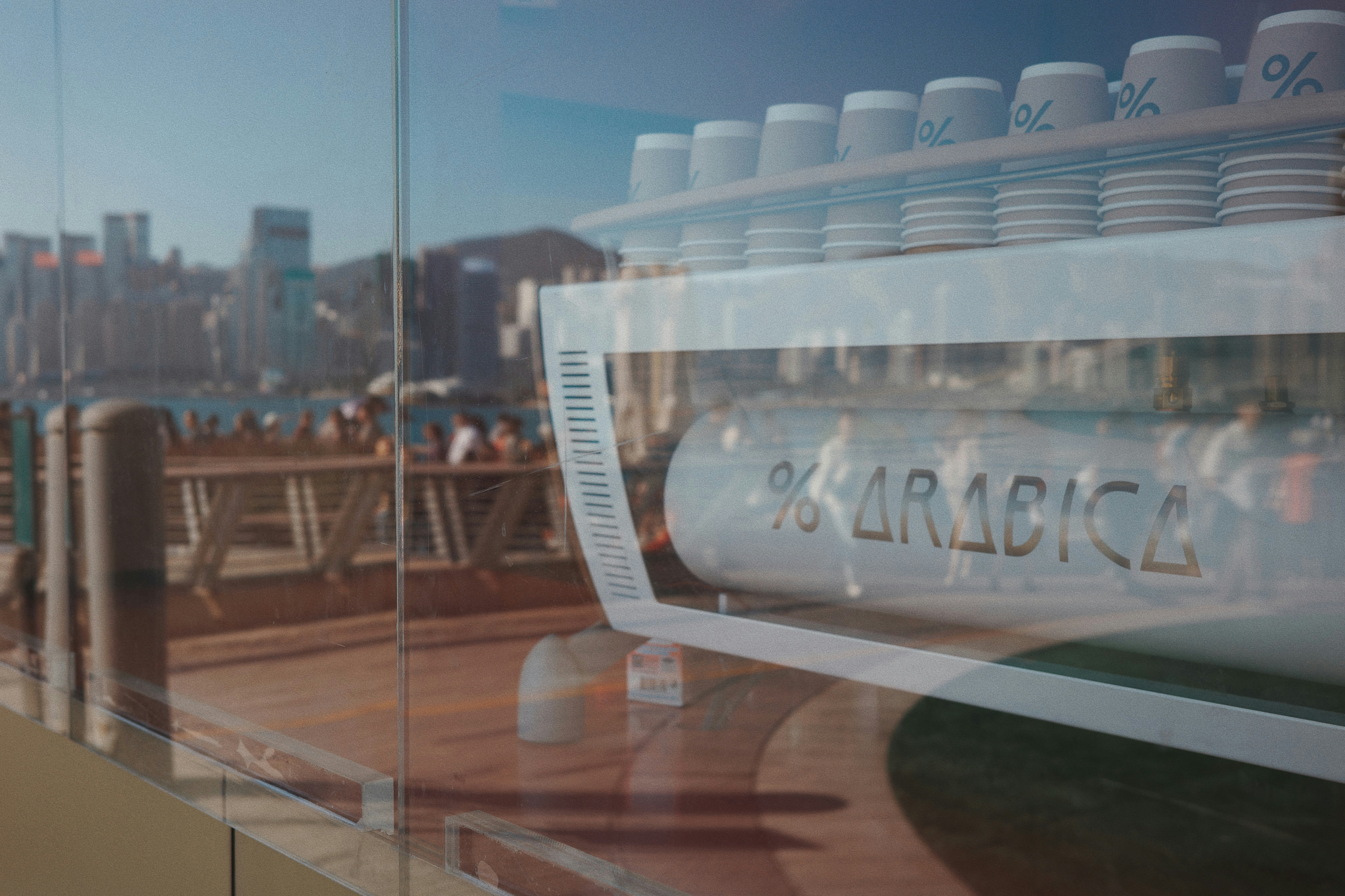 Coffee machine with cups and city reflection