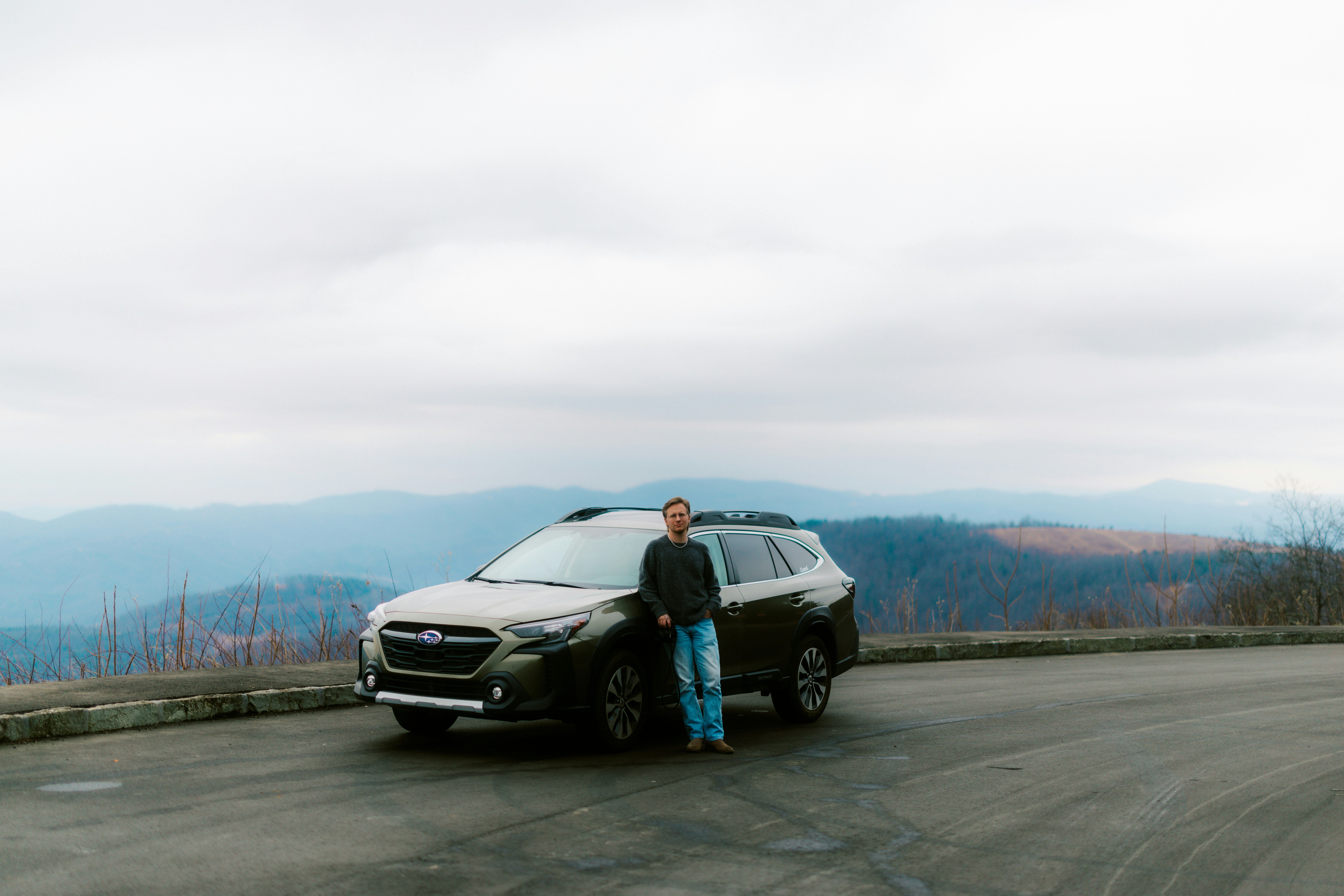 Mid-Altitude Resolve: A Man and SUV Paired on a Summit Road