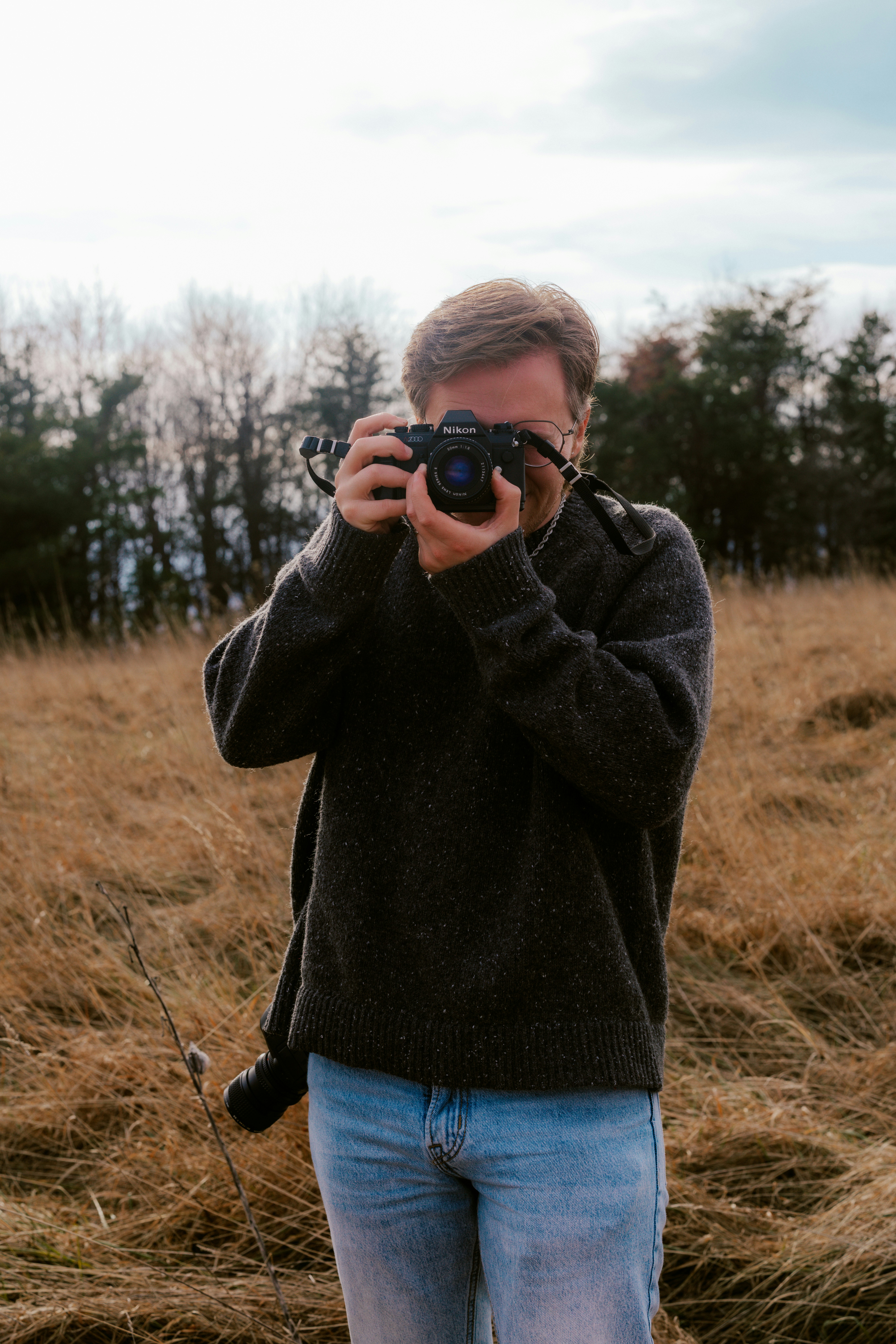 Portrait in the Field: A Moment Captured with a Nikon-branded Canon-style Cameraman