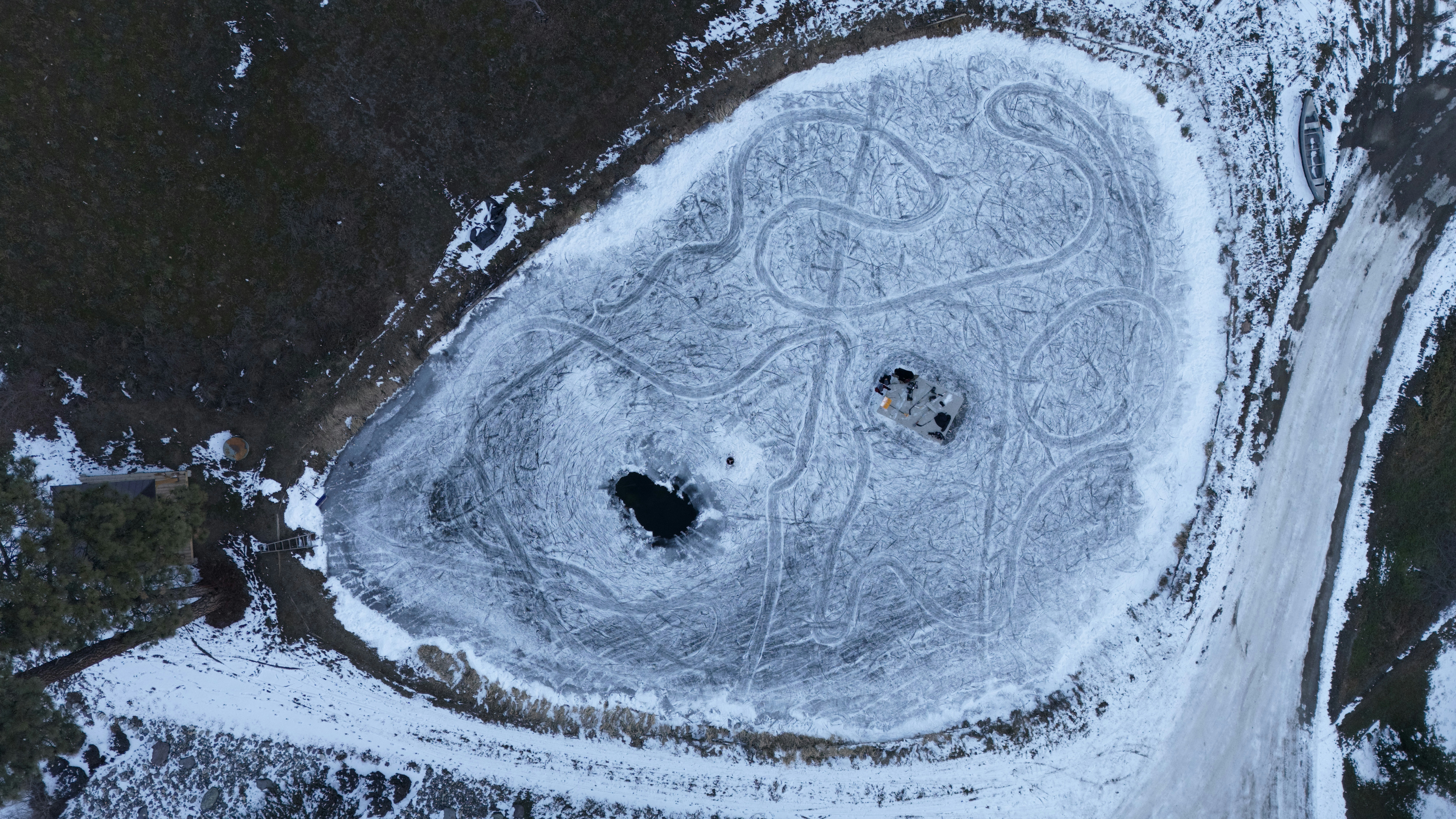 Snow-etched mystery: a circular stone enclosure with winding patterns